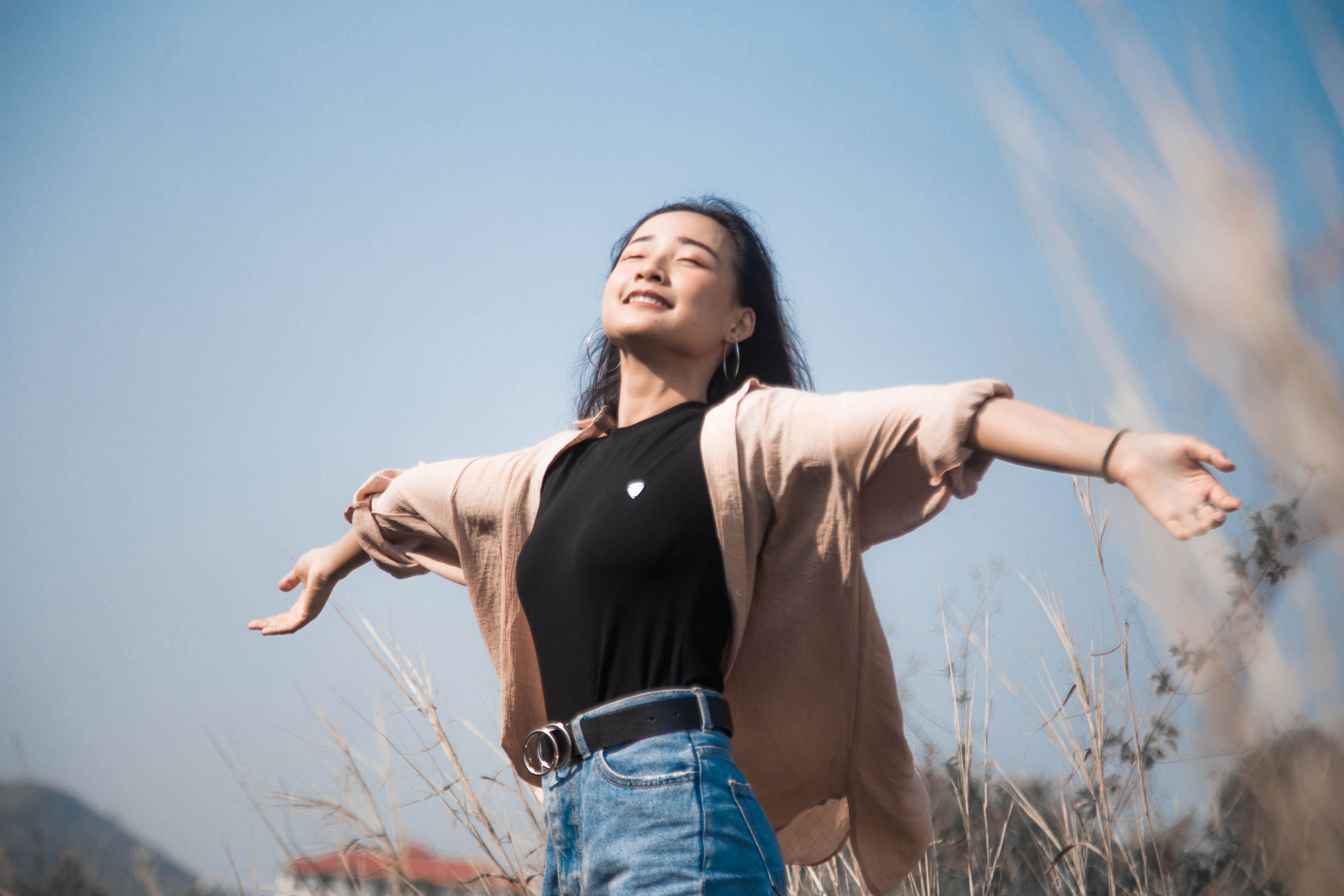 Photo of a Woman Smiling while Her Arms are Apart · Free Stock Photo