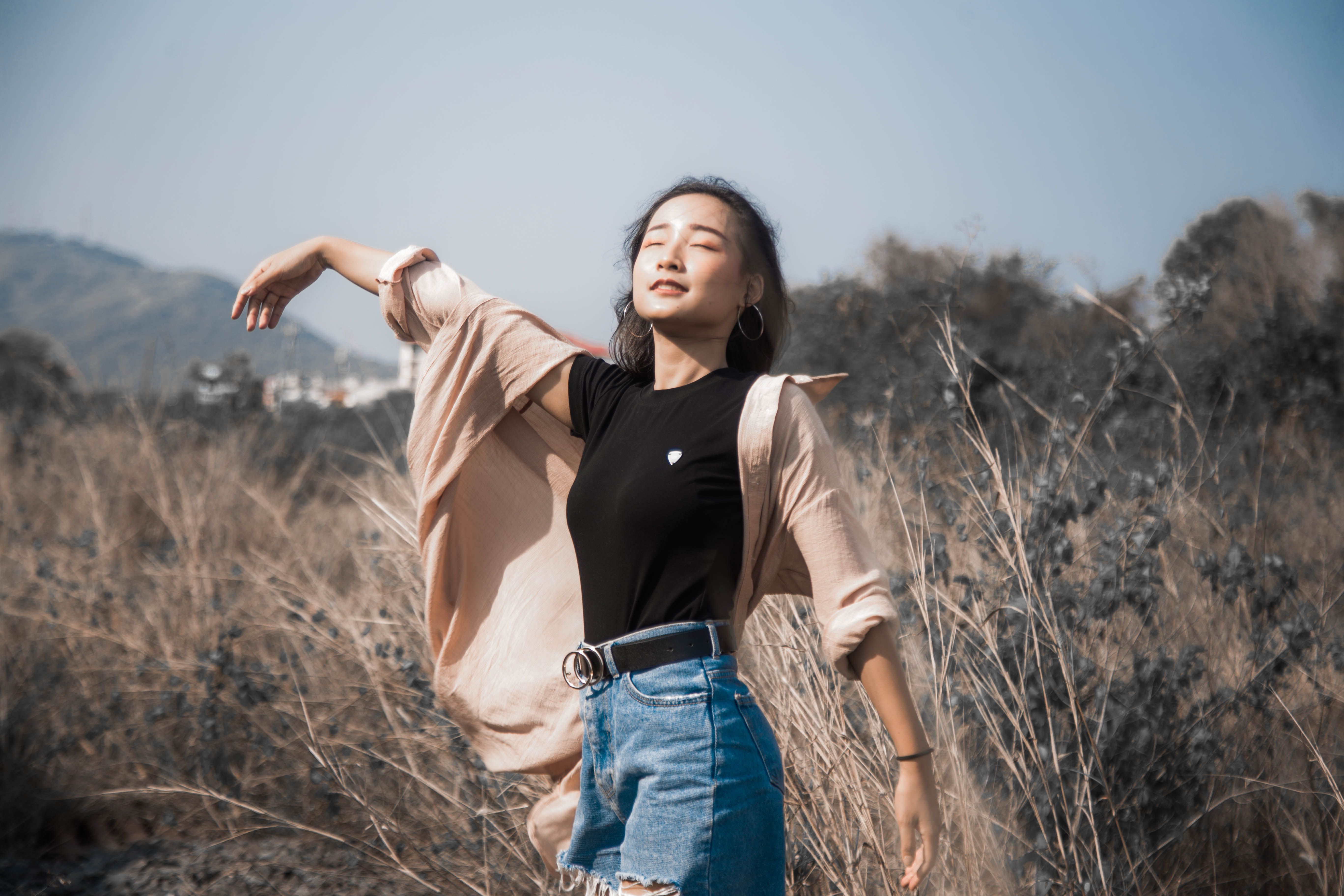 Woman in a Black Shirt Feeling the Wind · Free Stock Photo