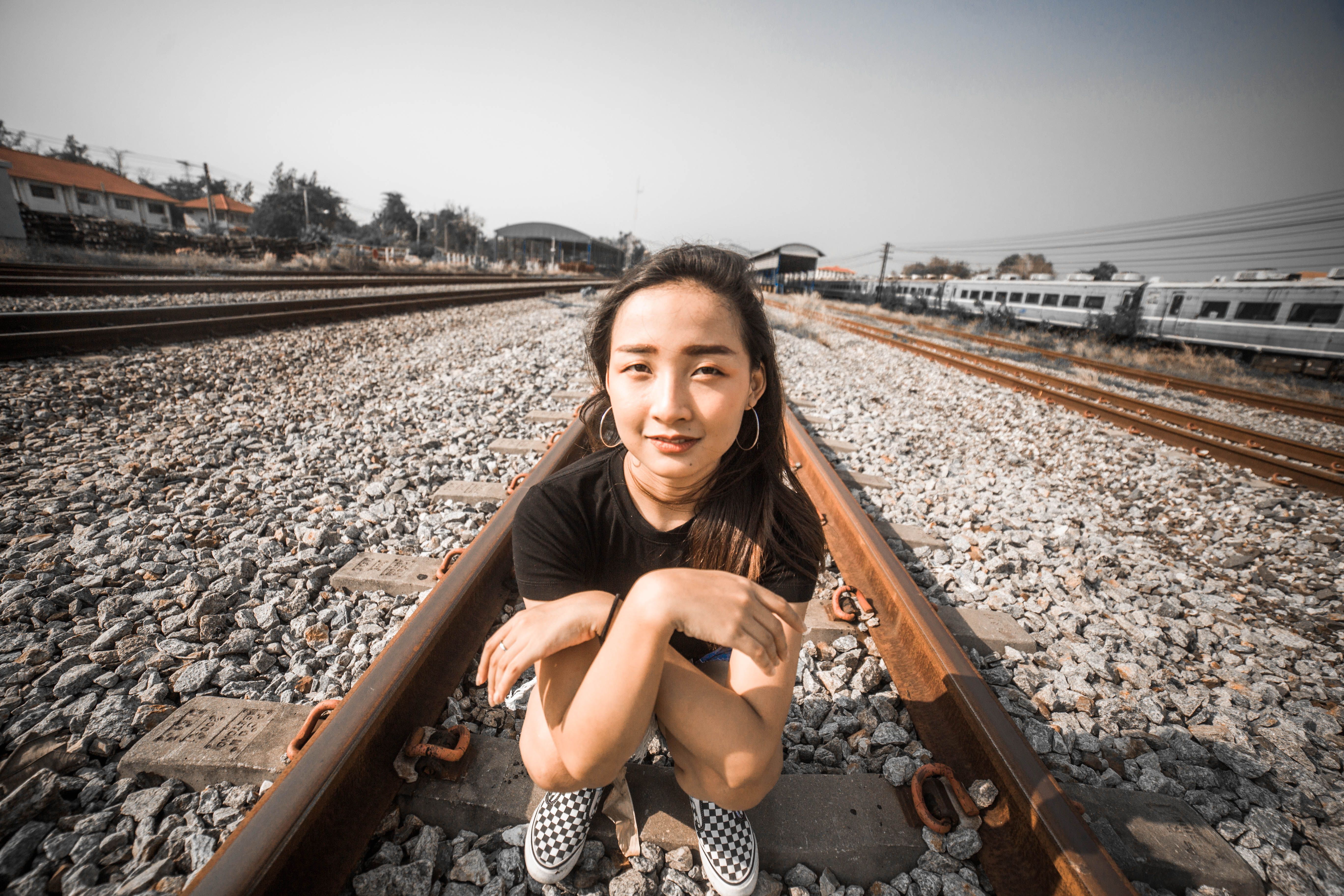 Girl Standing on a Railway Track · Free Stock Photo