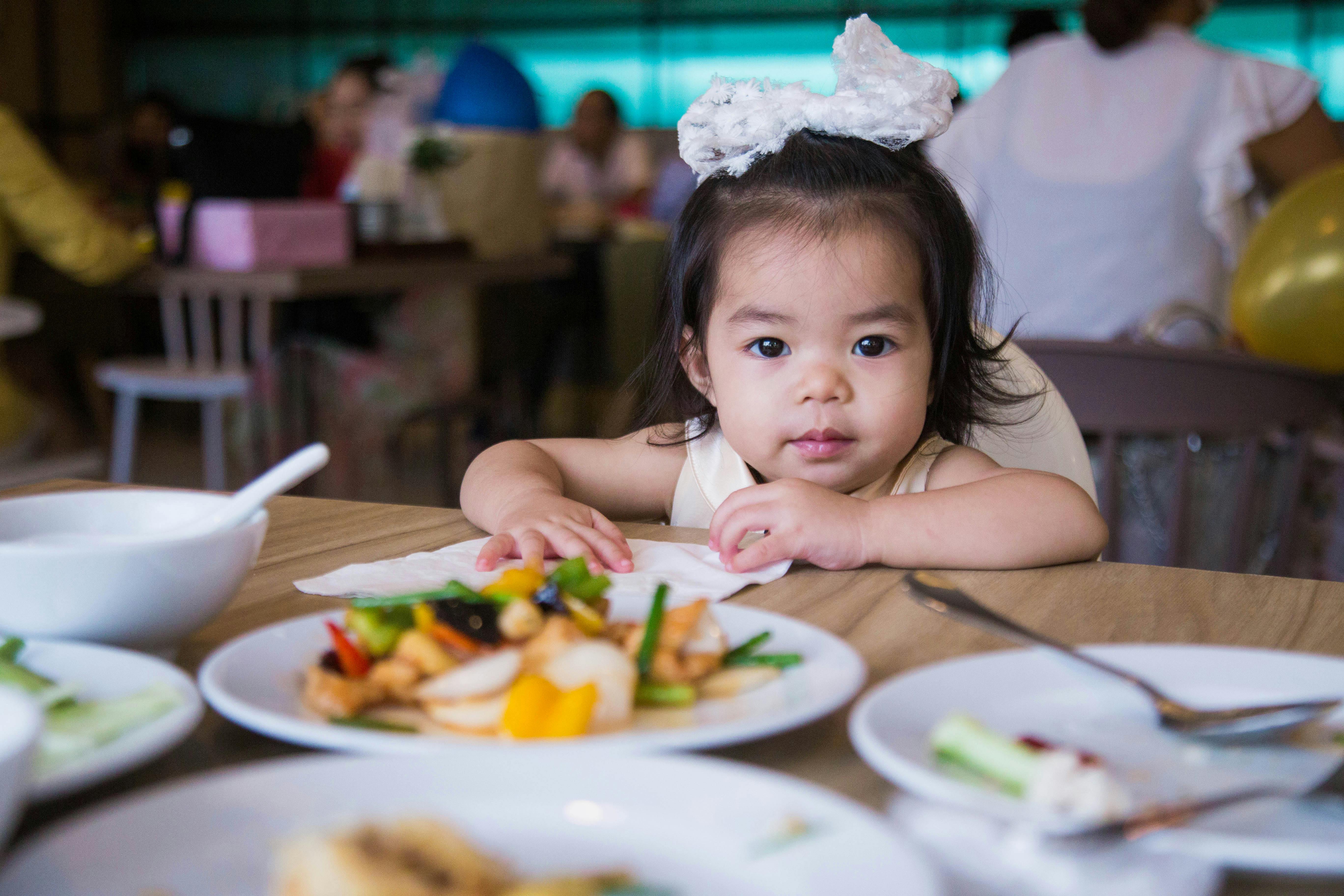 A Girl Sitting at a Table · Free Stock Photo