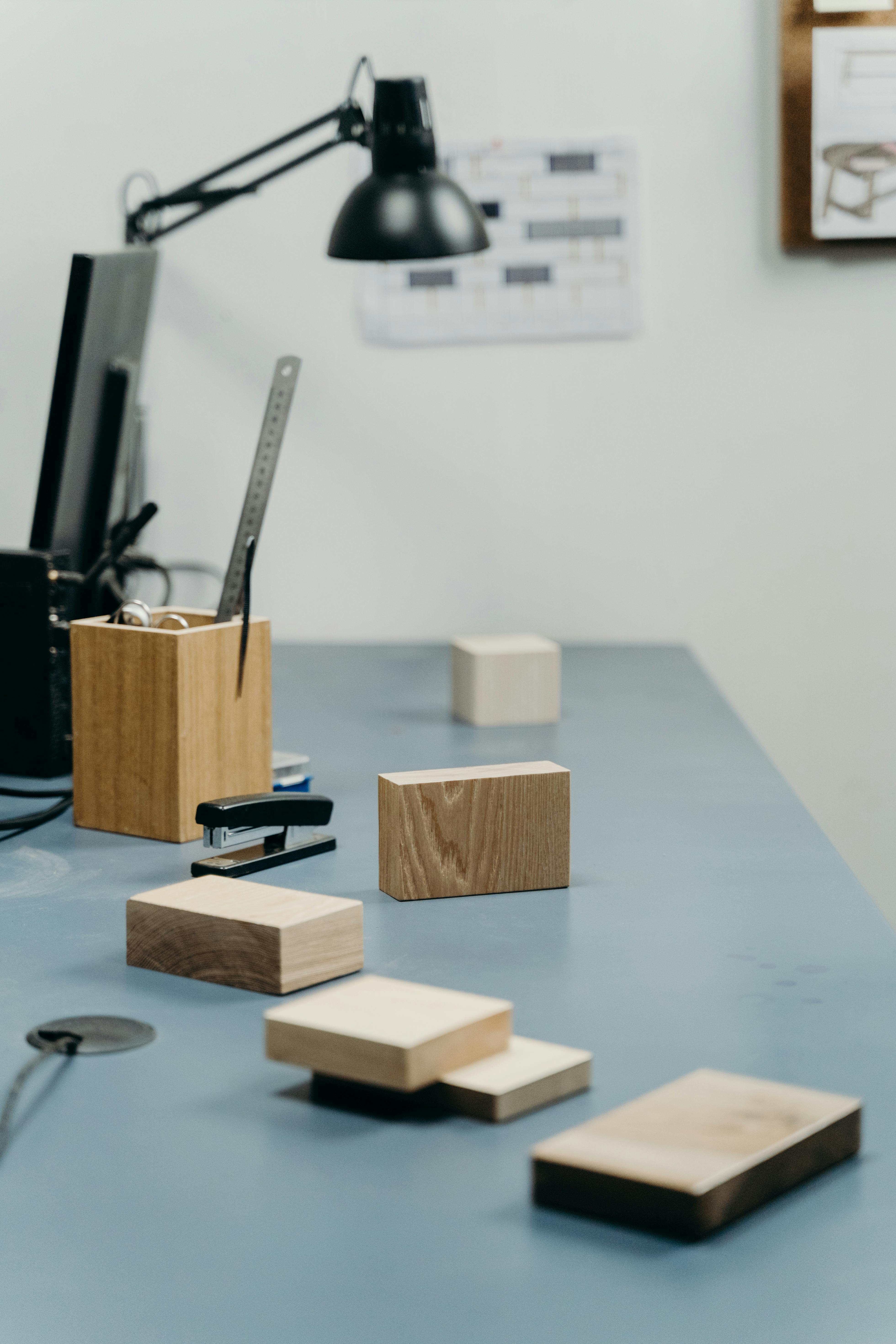 Photo of Brown Wooden Blocks on a Blue Desk · Free Stock Photo