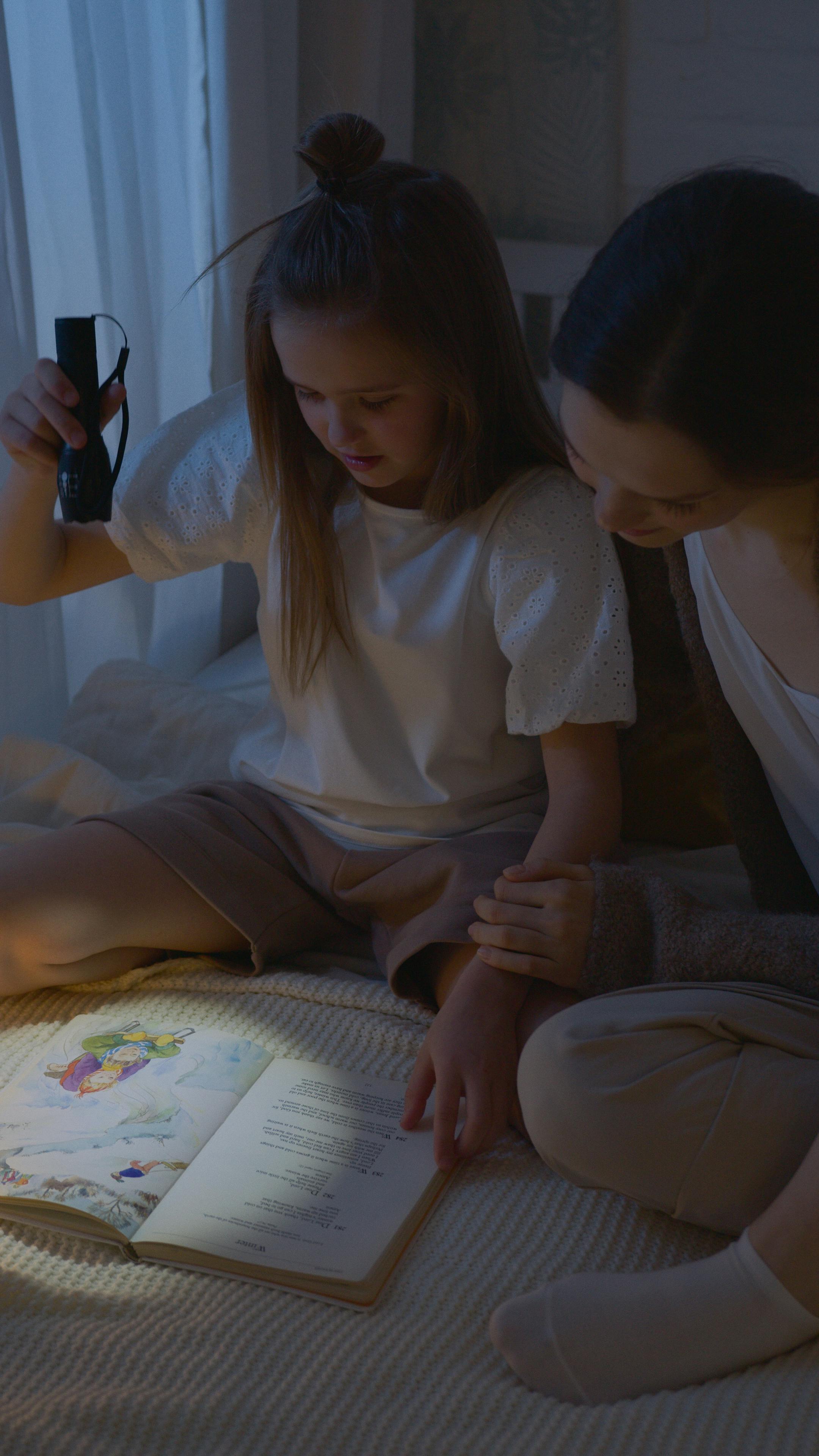 Photo of Siblings Reading a Book on the Bed · Free Stock Photo