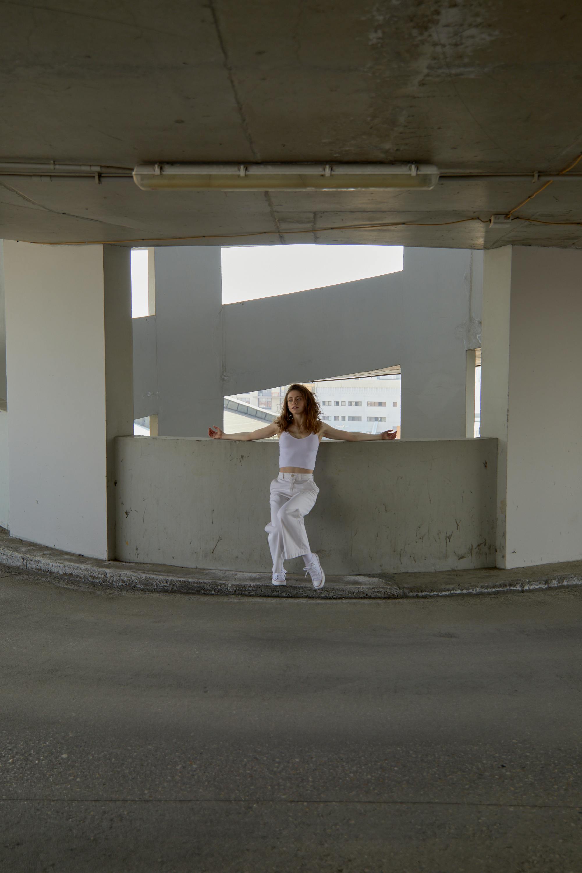 Woman Leaning on Concrete Railing · Free Stock Photo