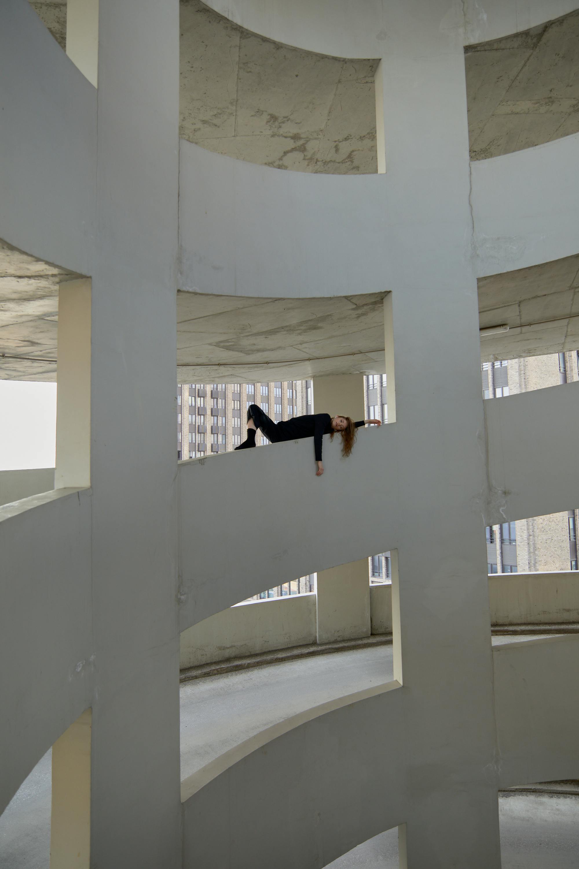 Woman Lying on Concrete Railing · Free Stock Photo