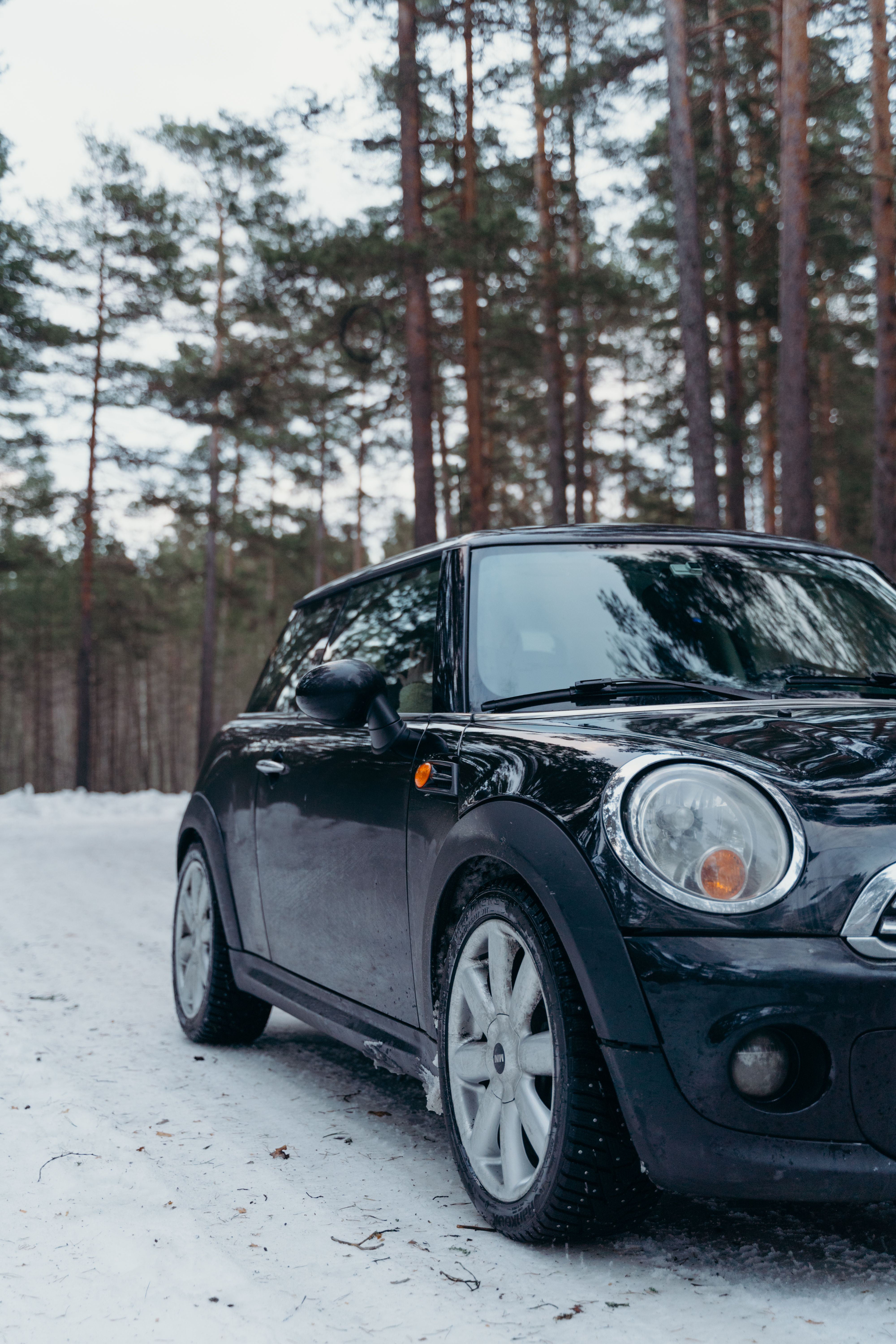 Close-Up Shot of a Black Car on Snowy Ground · Free Stock Photo