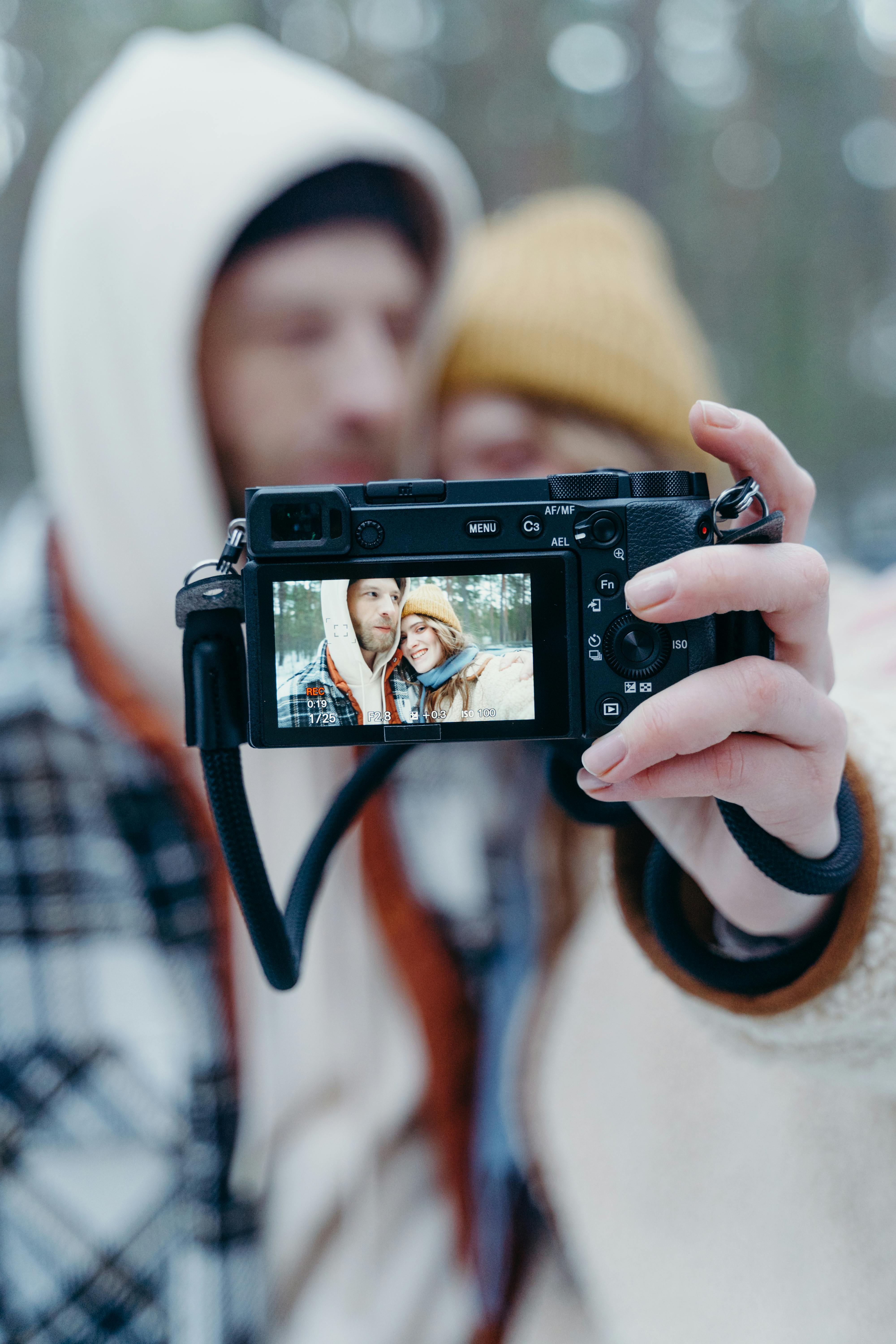 Couple Taking a Photo by a Camera · Free Stock Photo