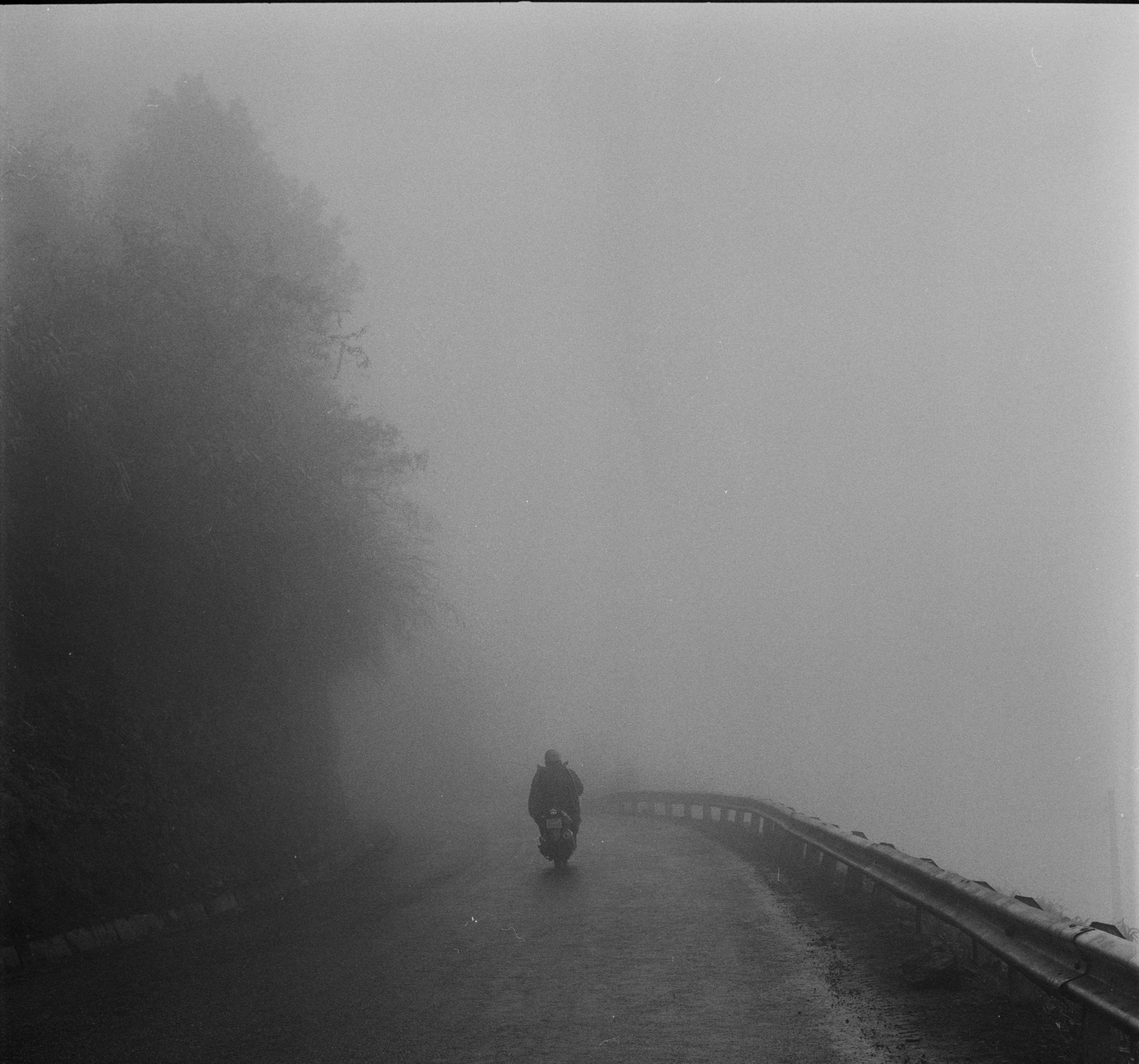 A Biker Riding on a Foggy Road · Free Stock Photo