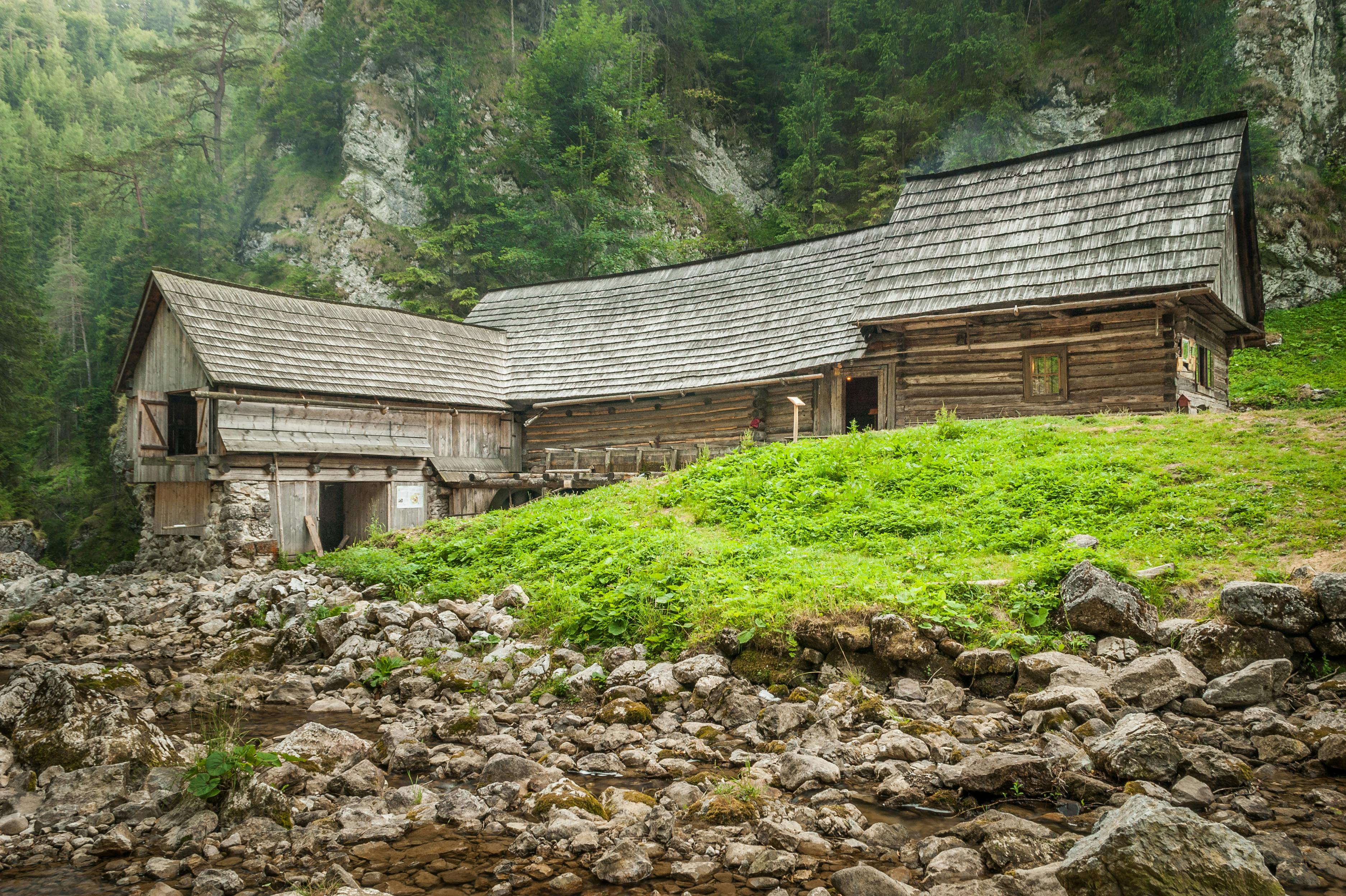 A Building With Roof Tiles Near Snowy Blue Mountains · Free Stock Photo