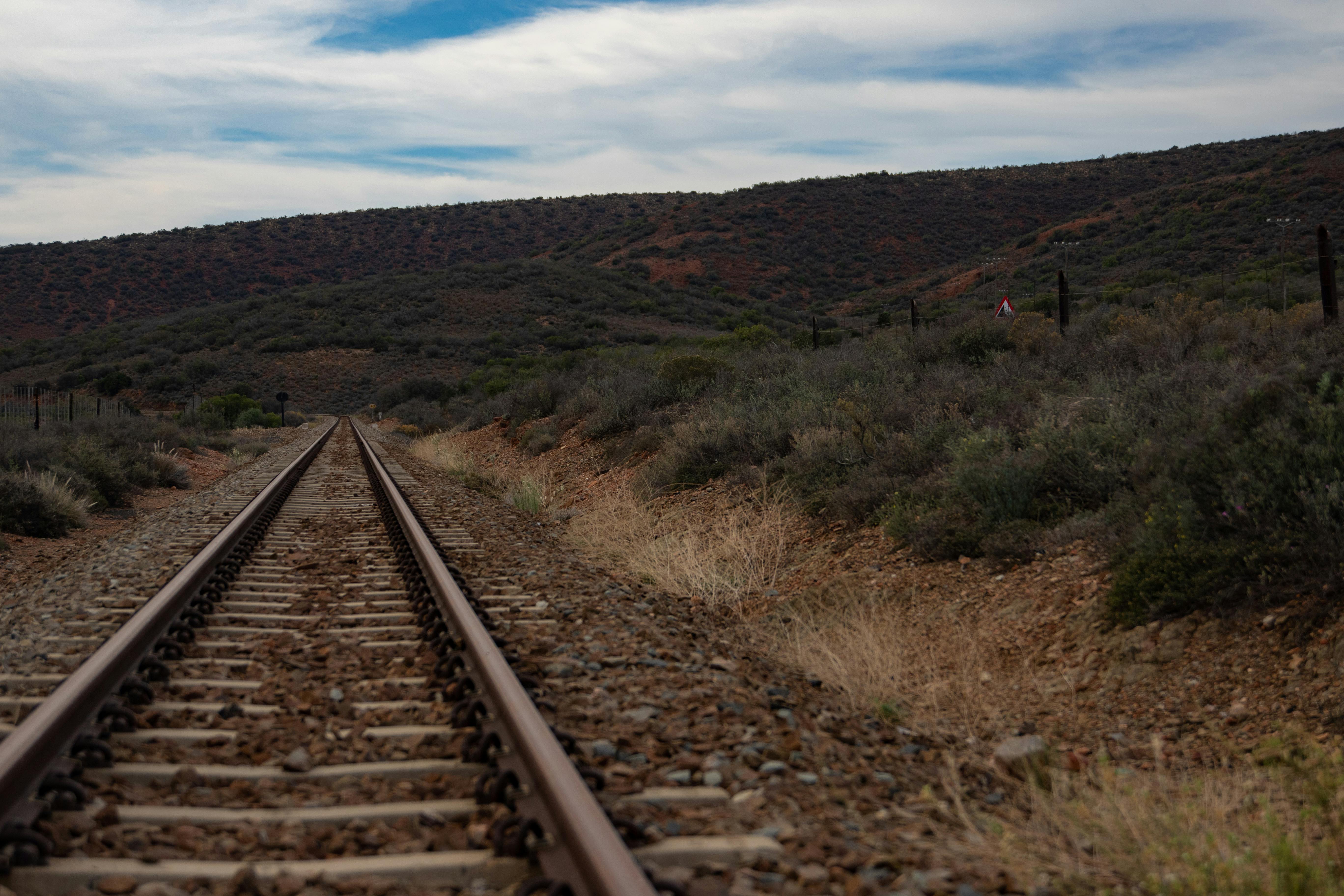 Photo Of Railway On Mountain Near Houses · Free Stock Photo