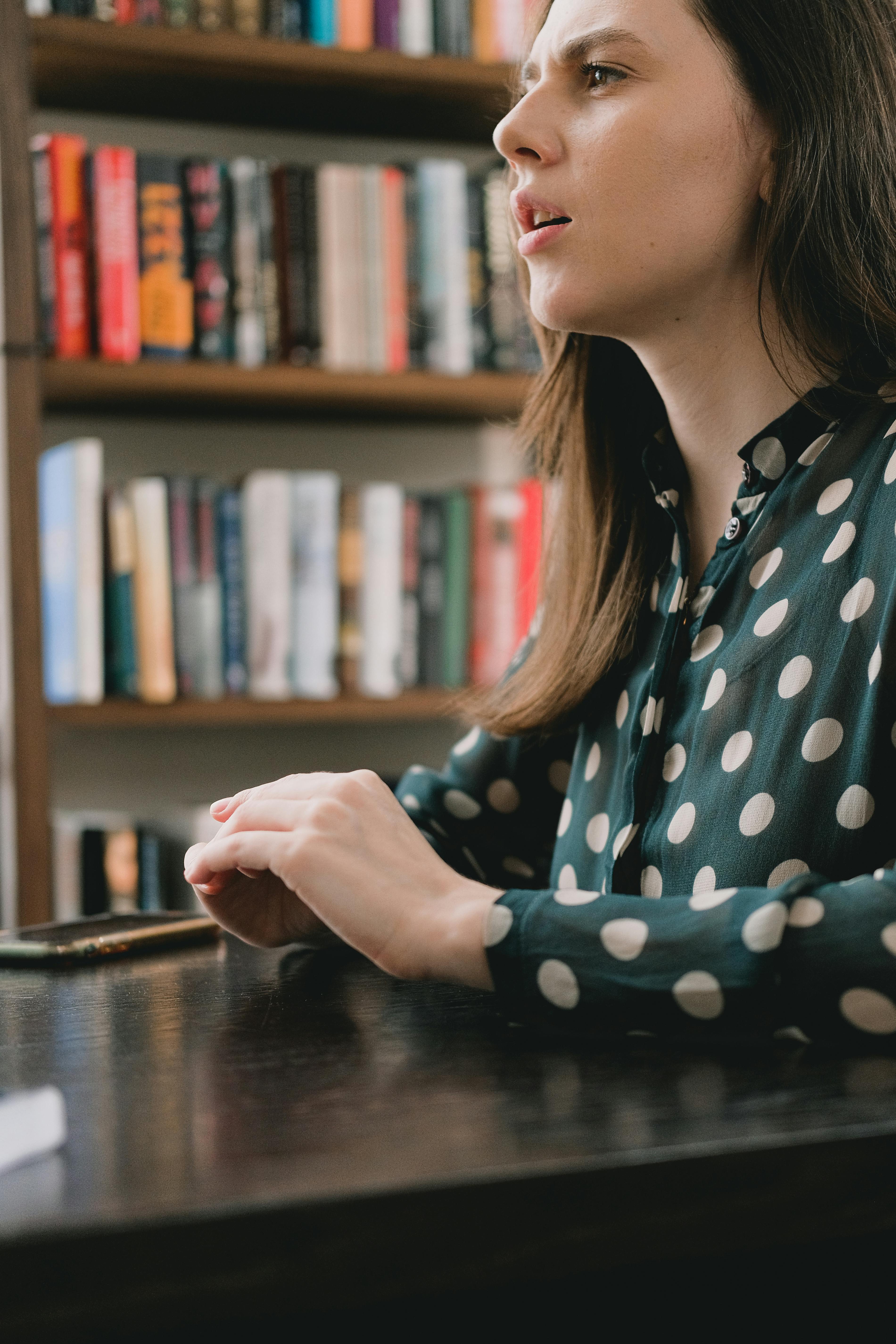 Serious young lady listening to lecture in university · Free Stock Photo