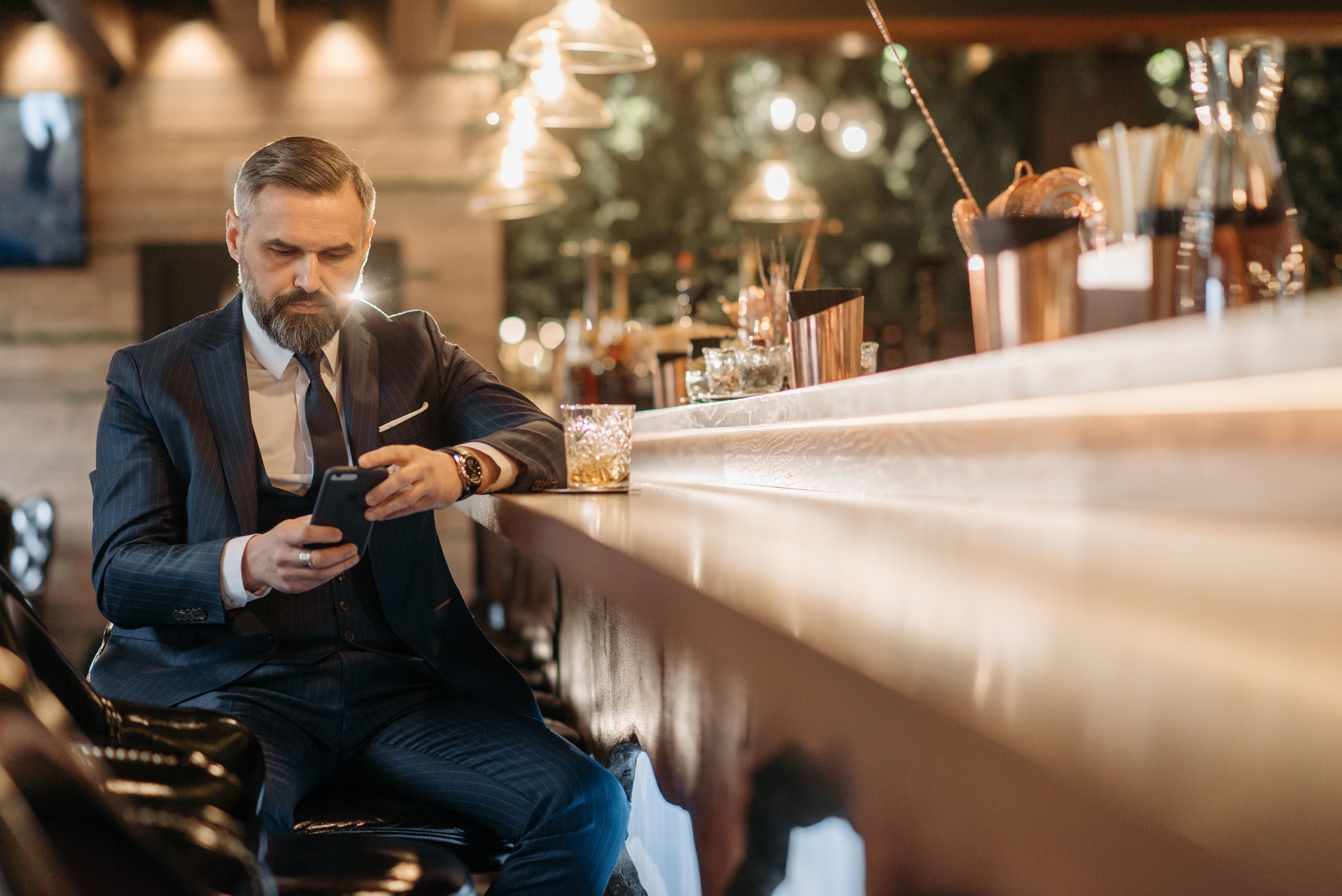 A Man Sitting at the Bar Counter · Free Stock Photo