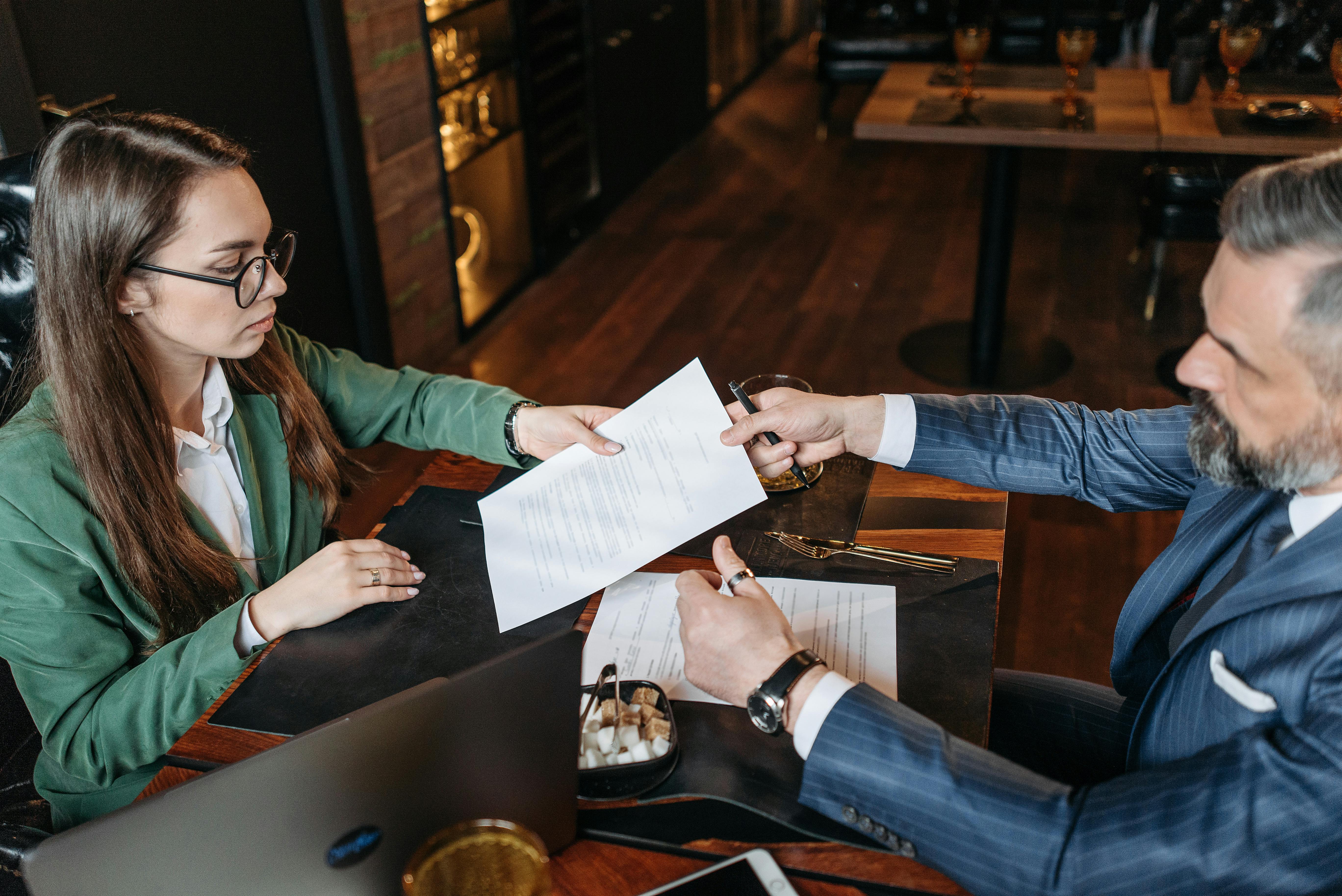 Woman Giving Paper to Man · Free Stock Photo