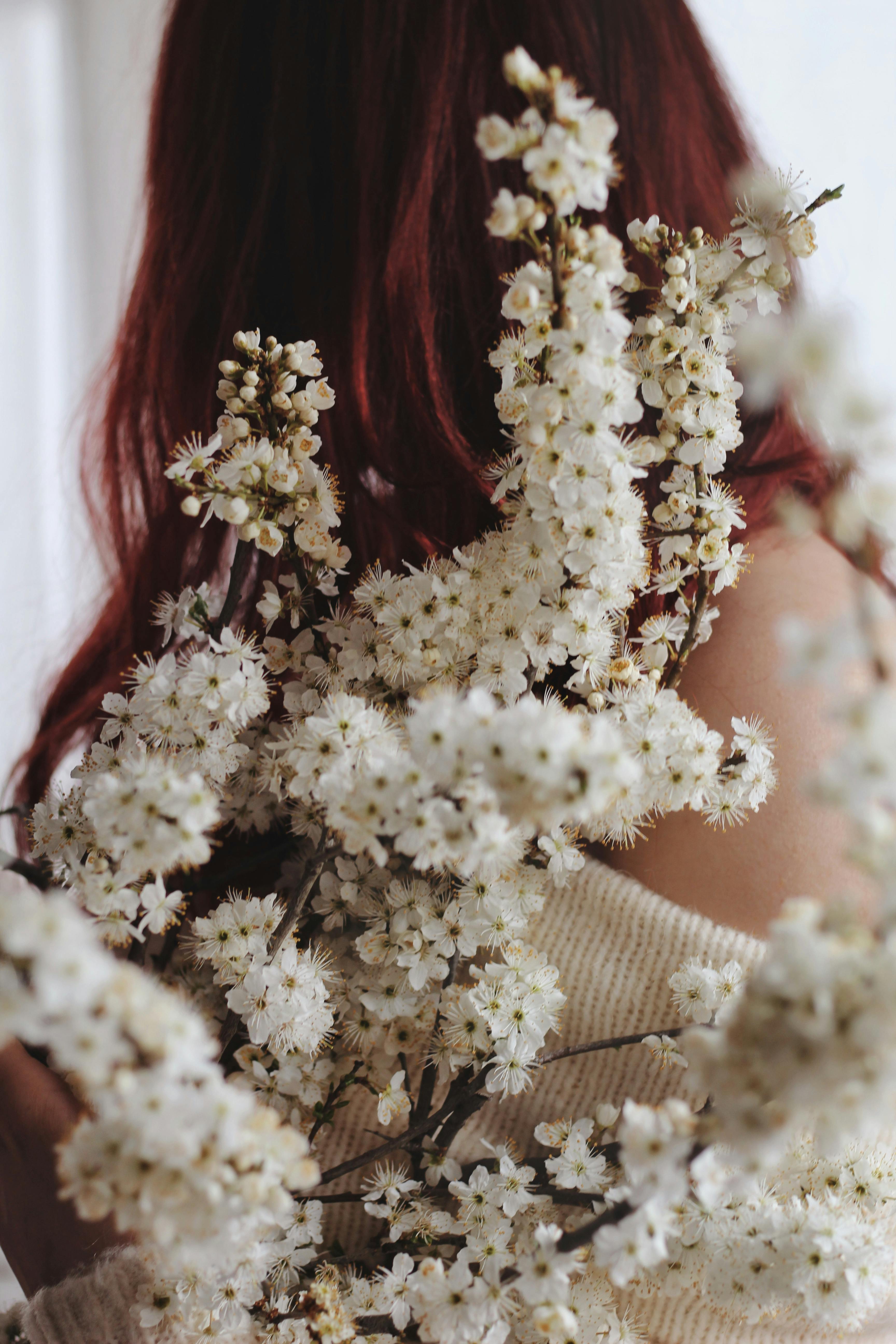 Woman Holding a Flower Behind Her Back · Free Stock Photo