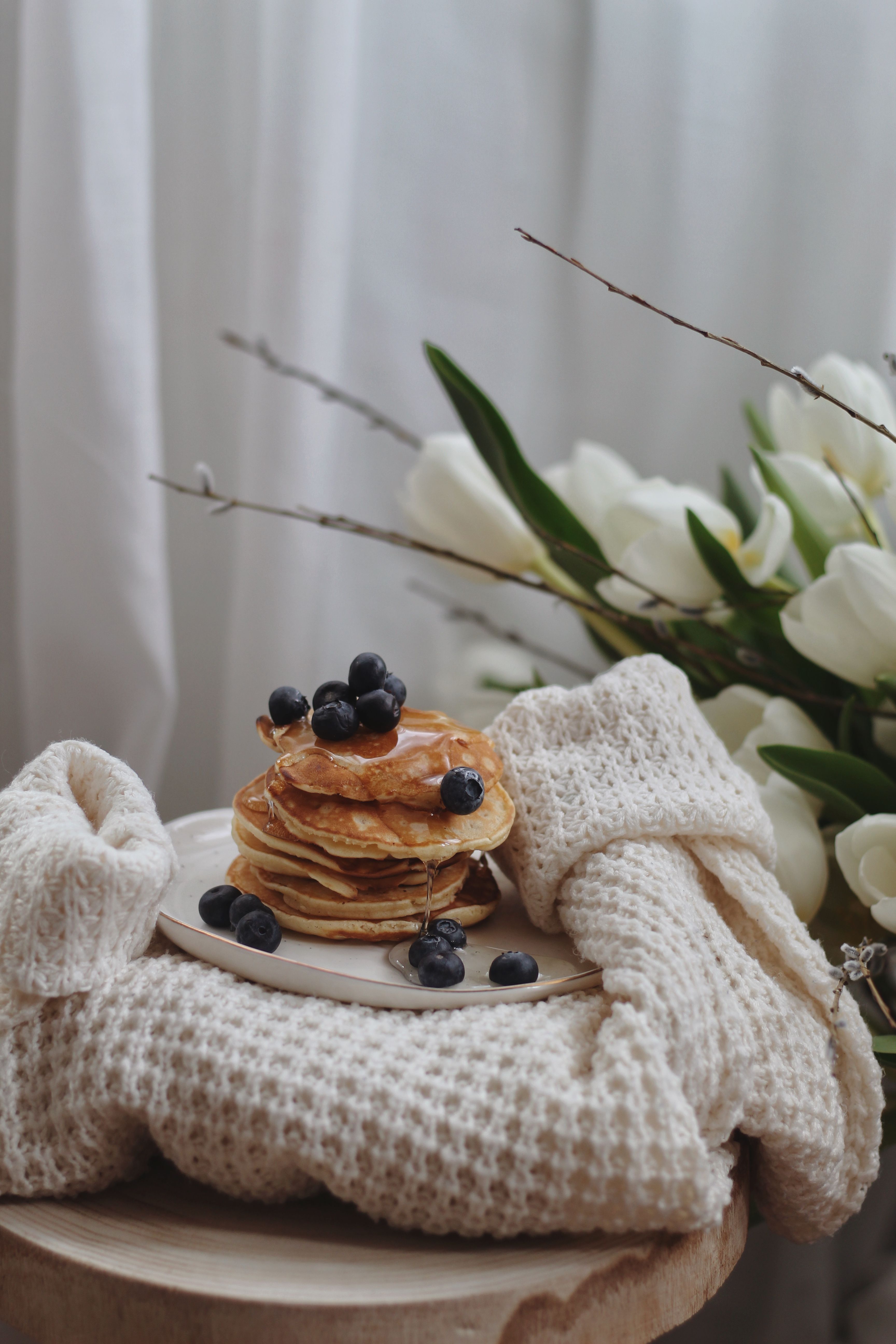 Plate of delicious pancakes with berries and maple syrup placed on ...