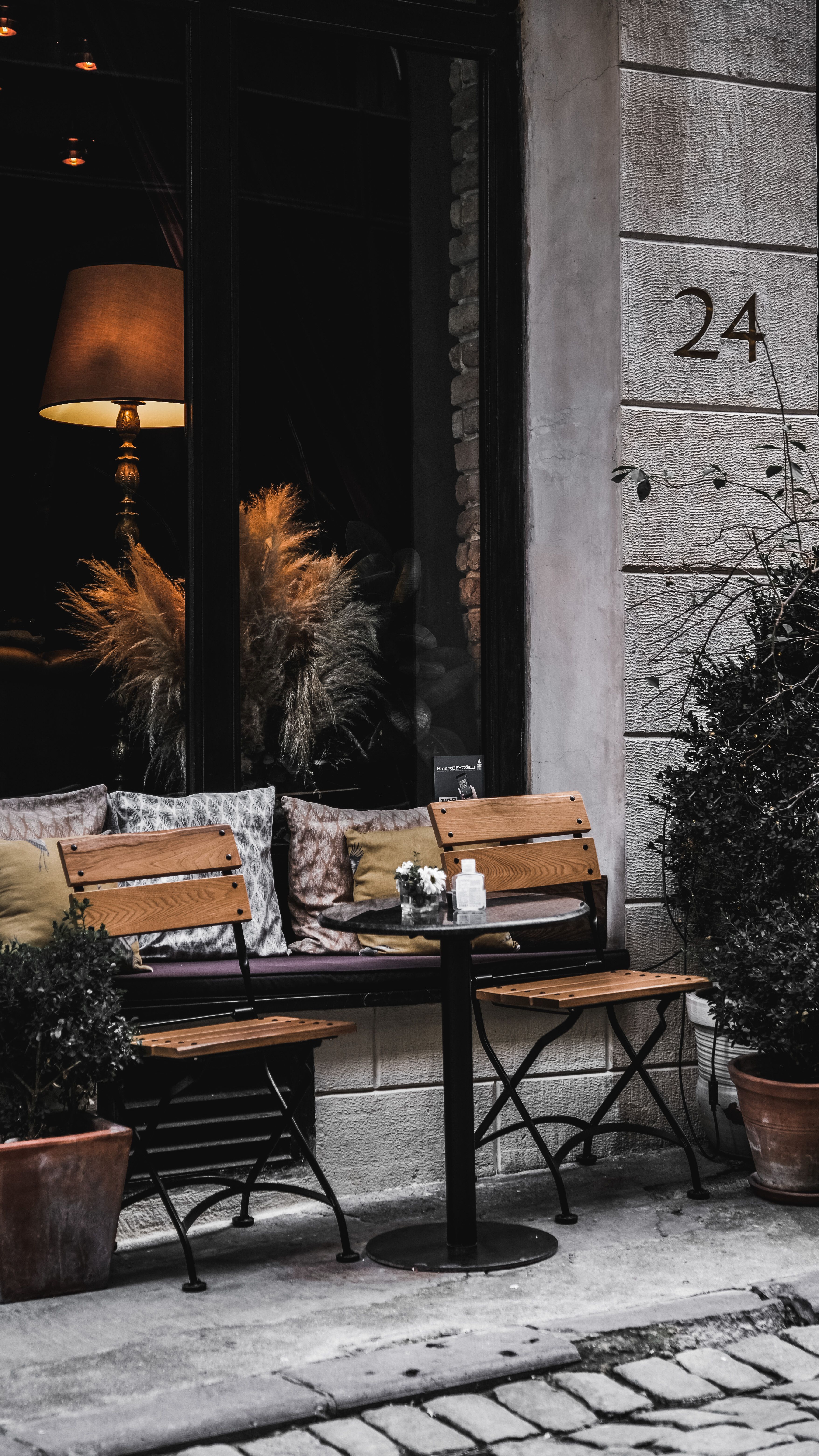 Cafe terrace with chairs near table · Free Stock Photo