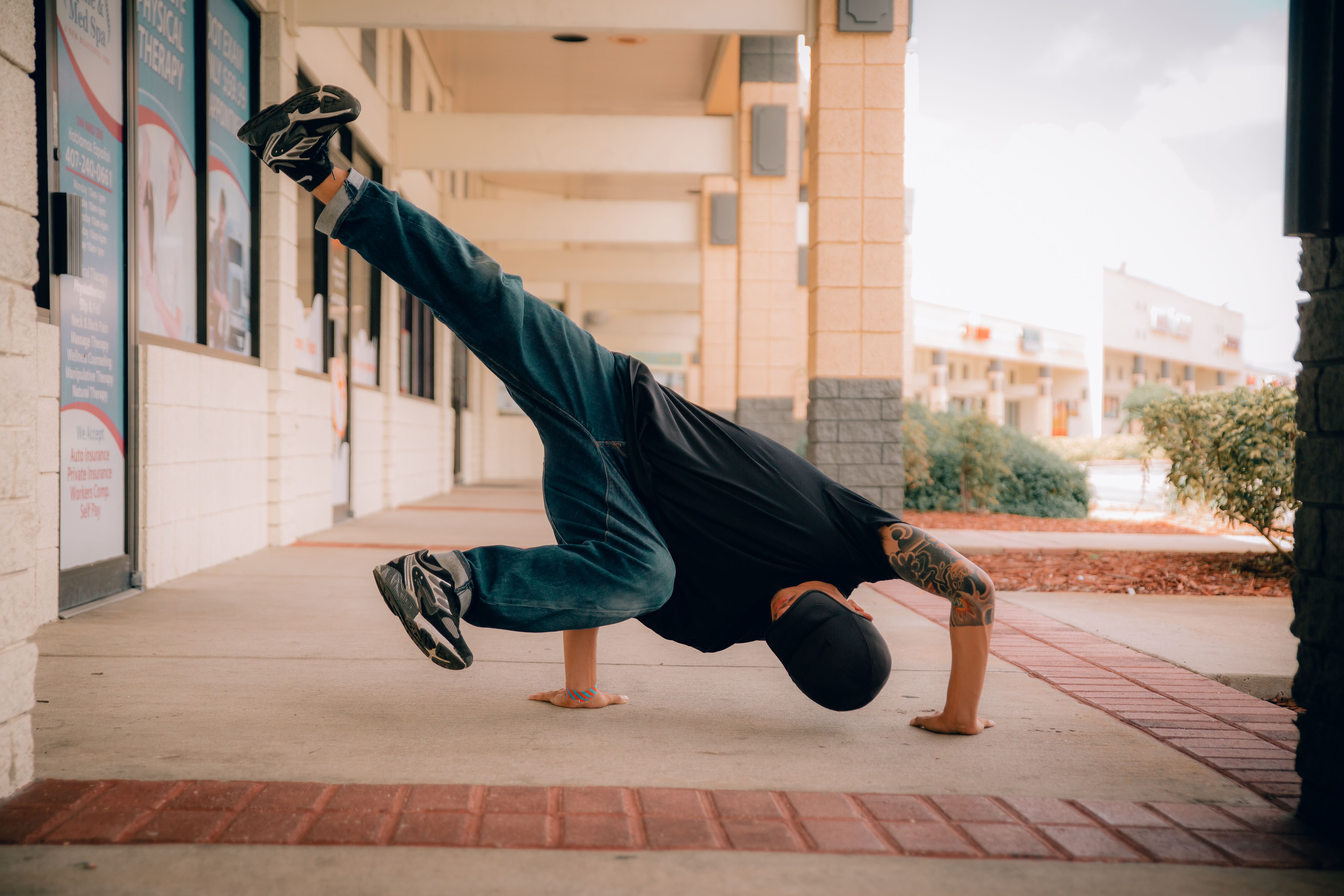 A Man Break Dancing on the Concrete Floor · Free Stock Photo