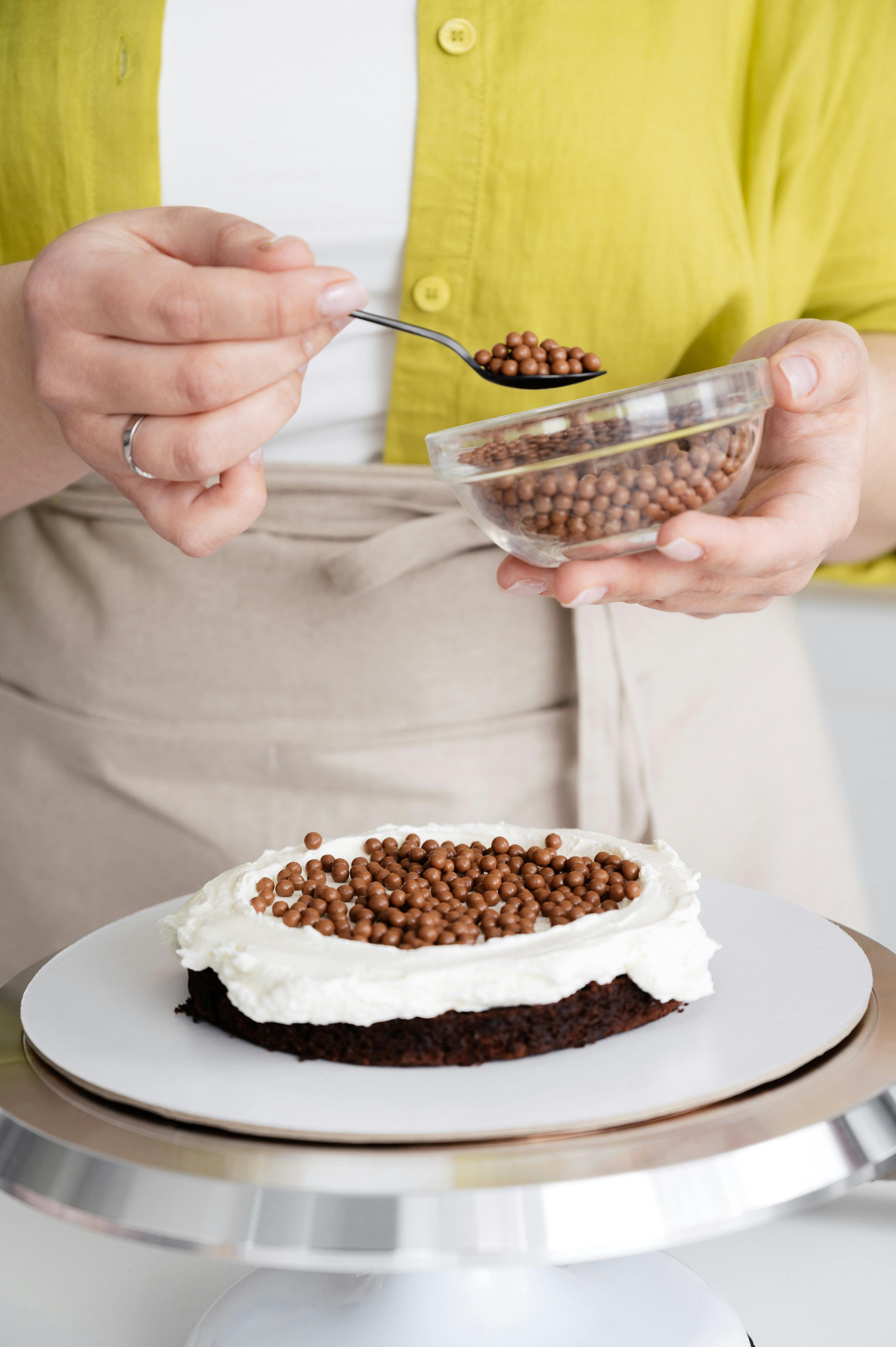 Crop woman making cake with cereal · Free Stock Photo