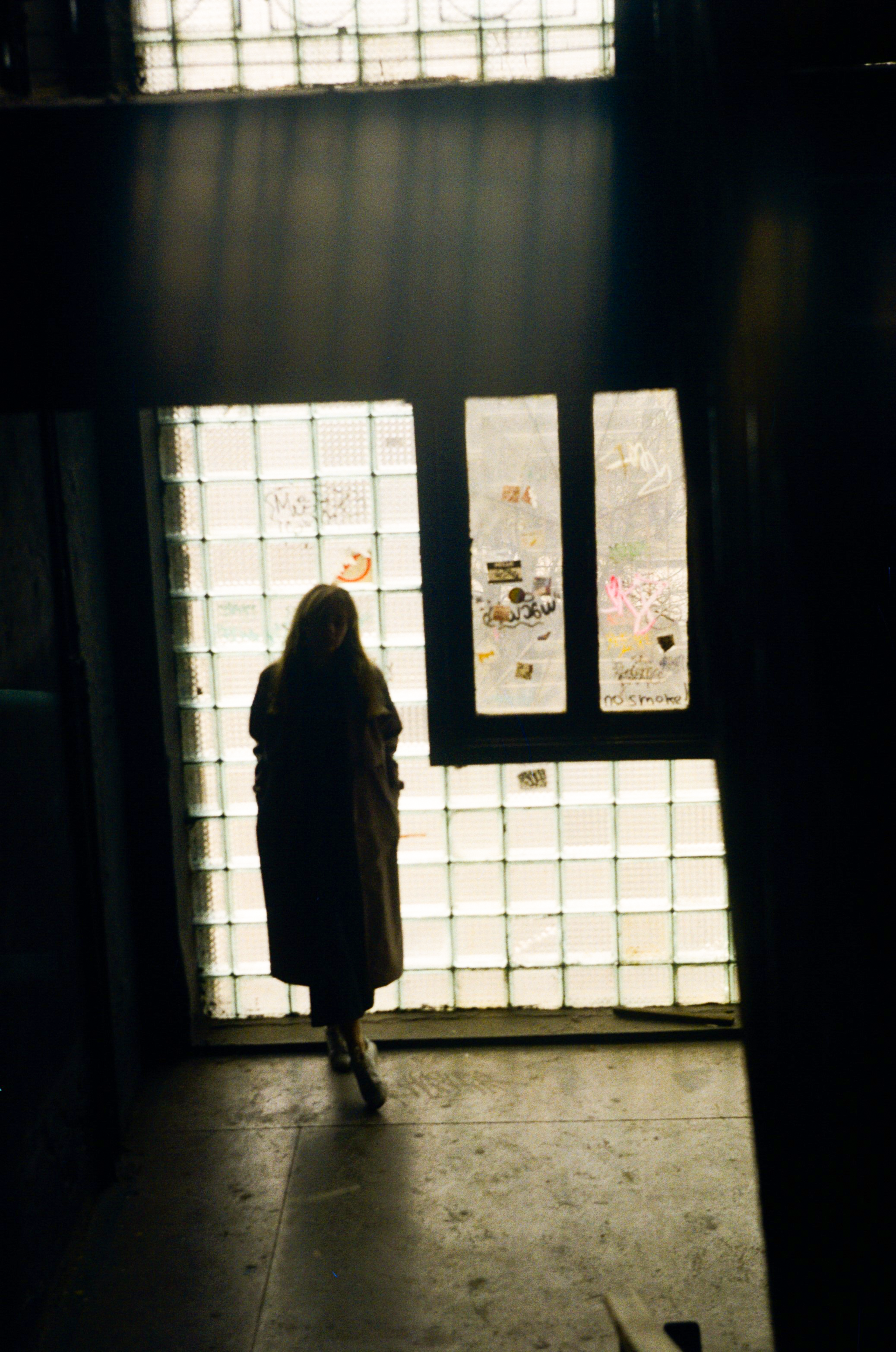 Woman Standing Beside Window · Free Stock Photo