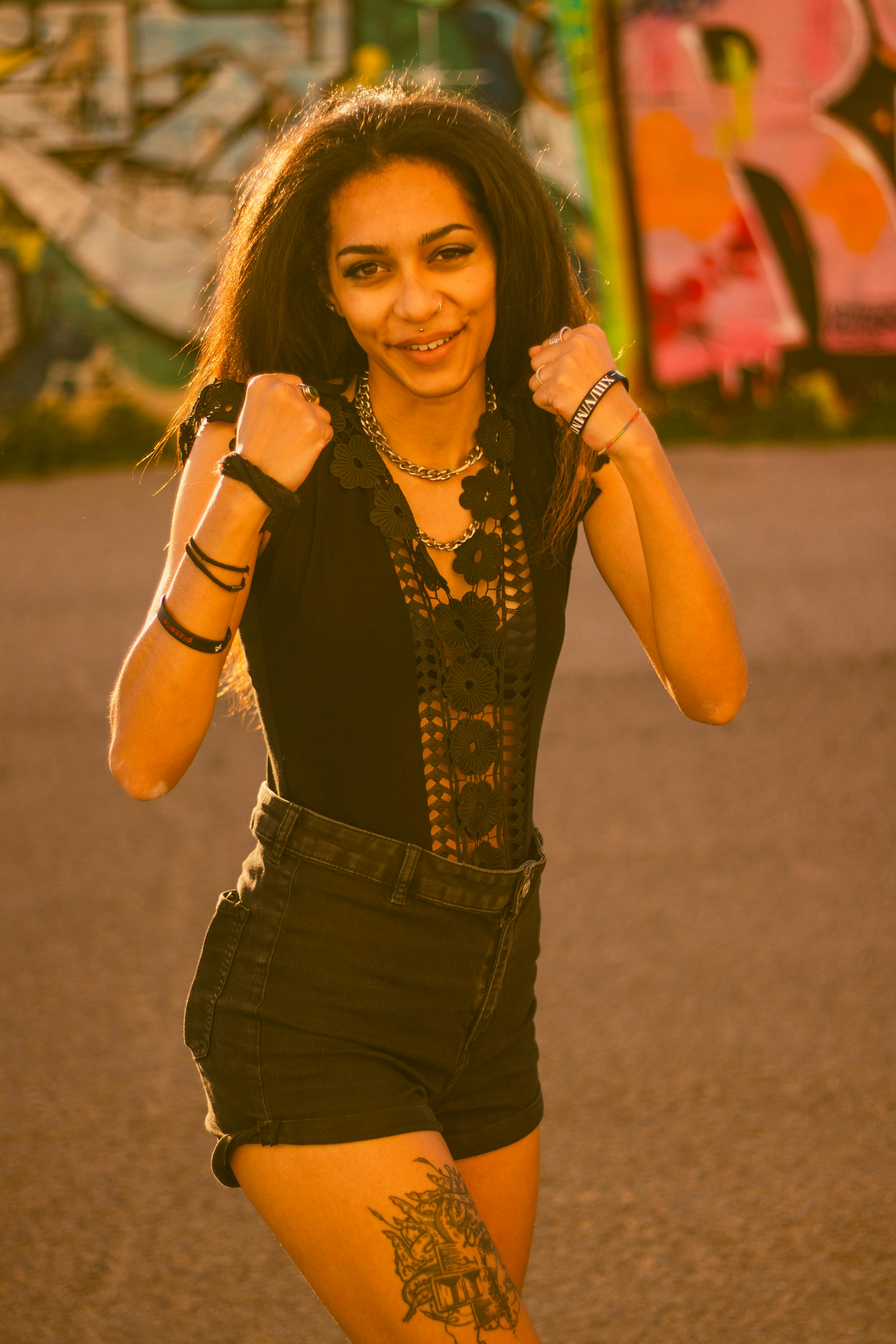 Woman Standing with Fist Up · Free Stock Photo