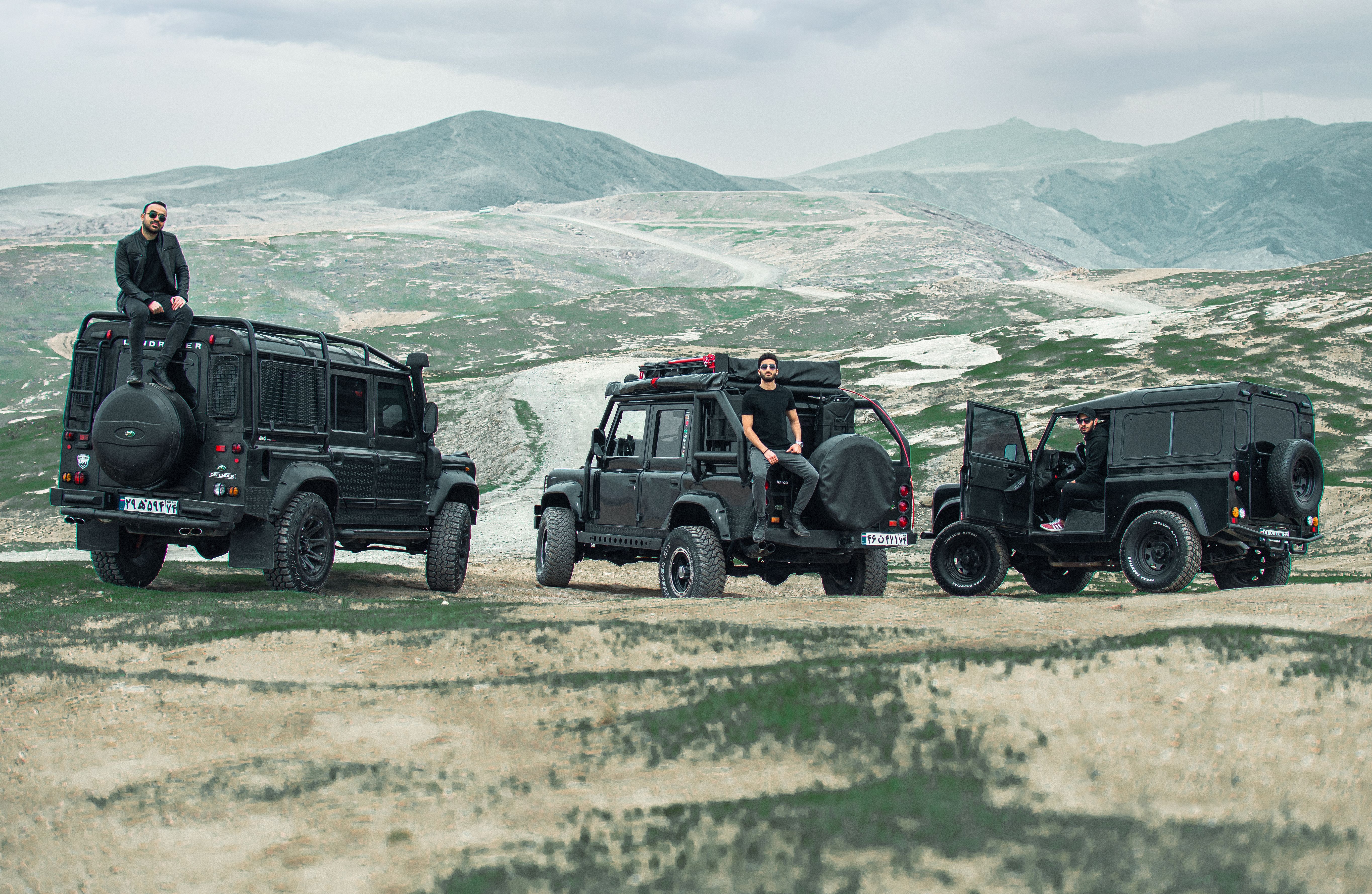 Cool Men Posing With Their Cars in front of a Winding Road · Free Stock ...