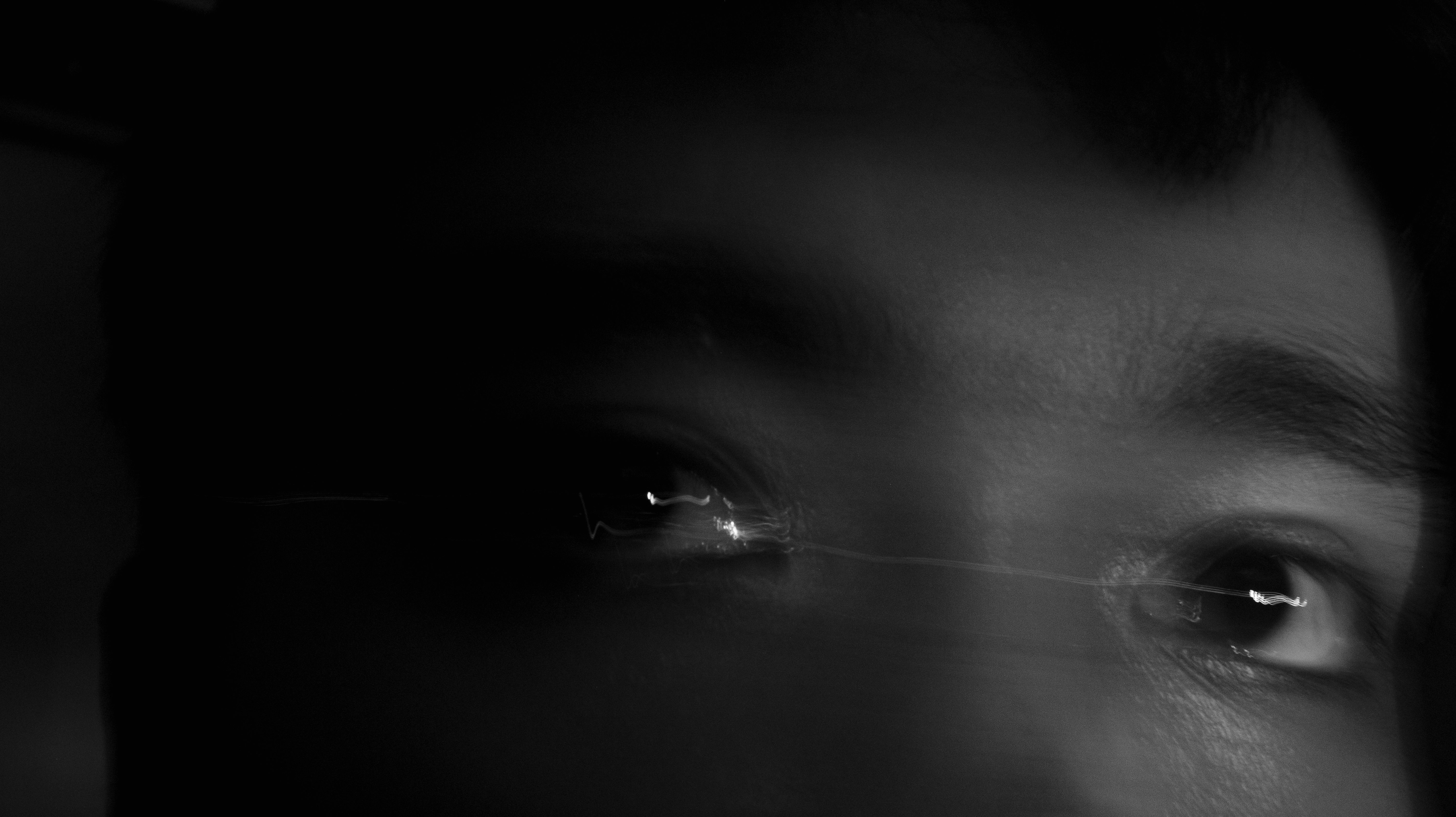 Human face peeping out of darkness · Free Stock Photo