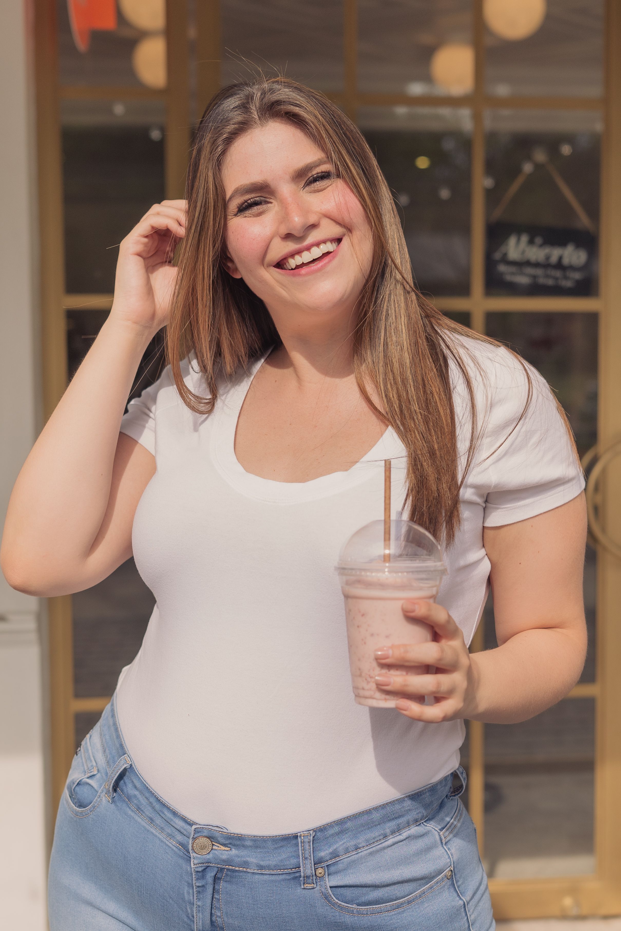 Beautiful Woman Holding a Milkshake while Smiling at the Camera · Free ...