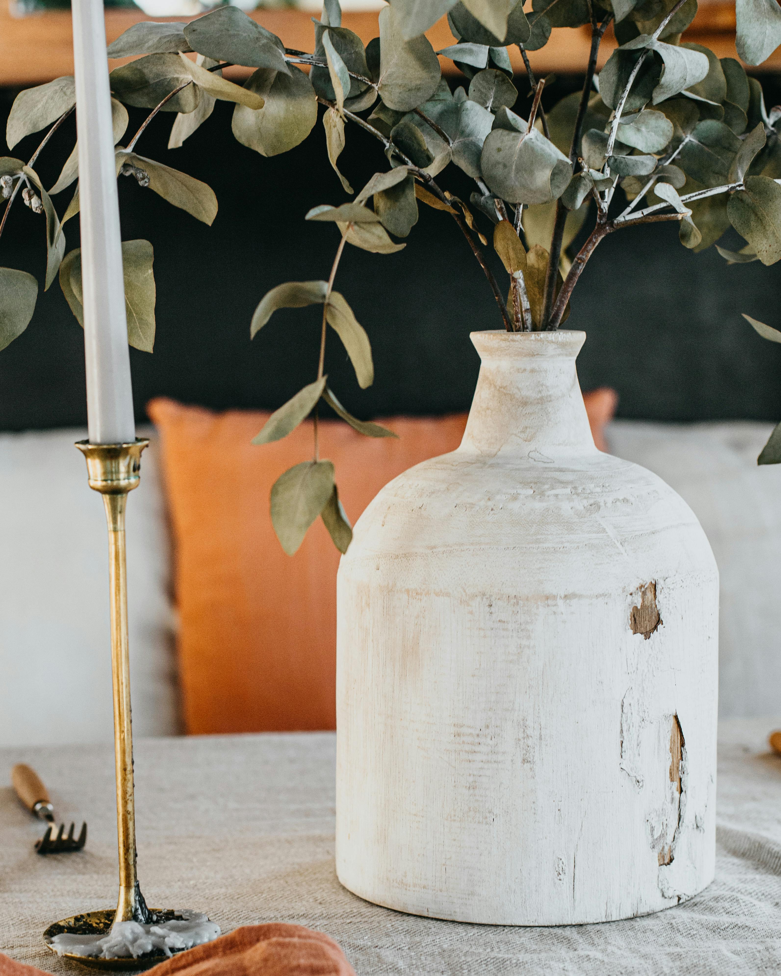 Jar with Twigs and a Vertical Candle · Free Stock Photo