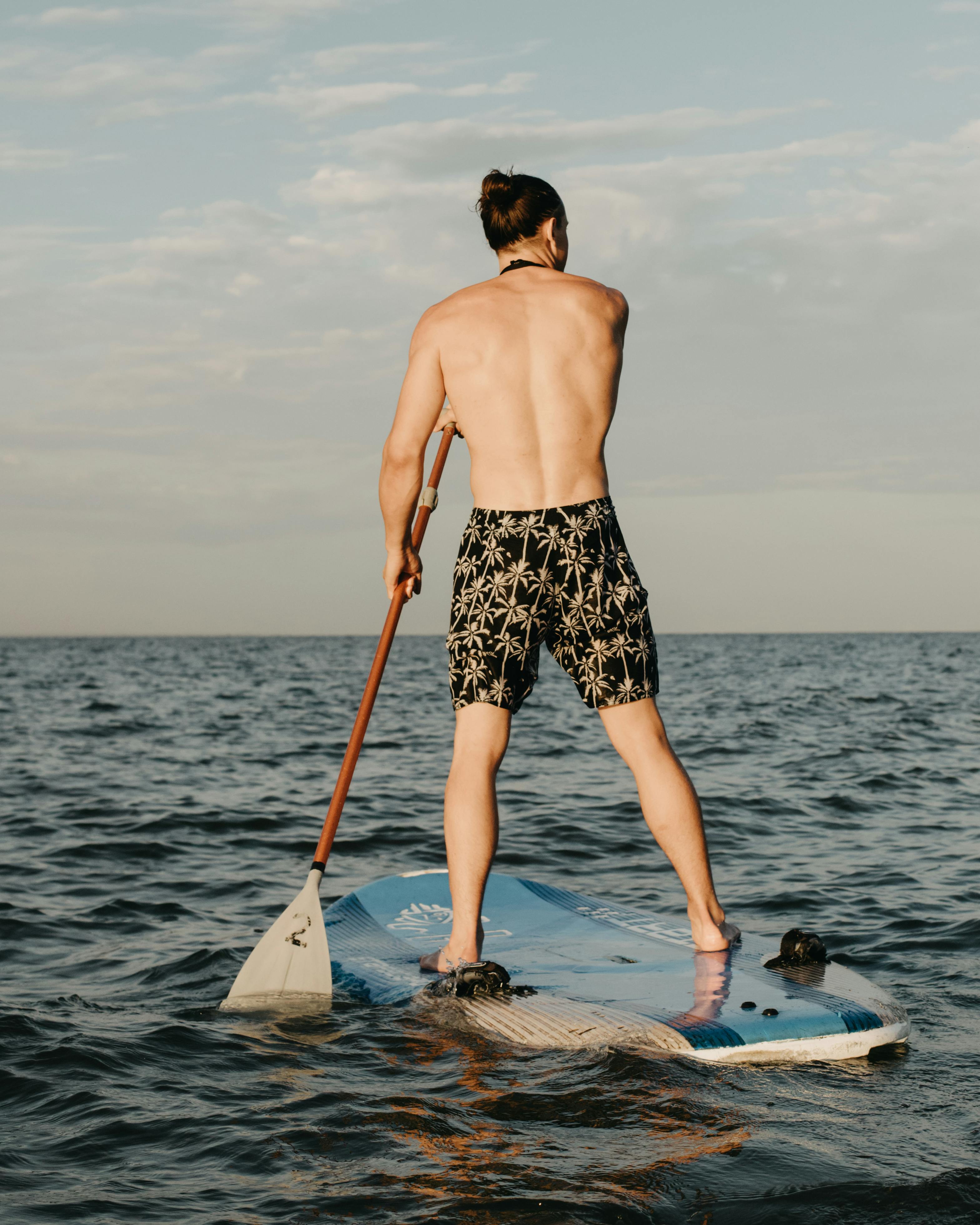 Man Riding on Paddleboard on Sea · Free Stock Photo