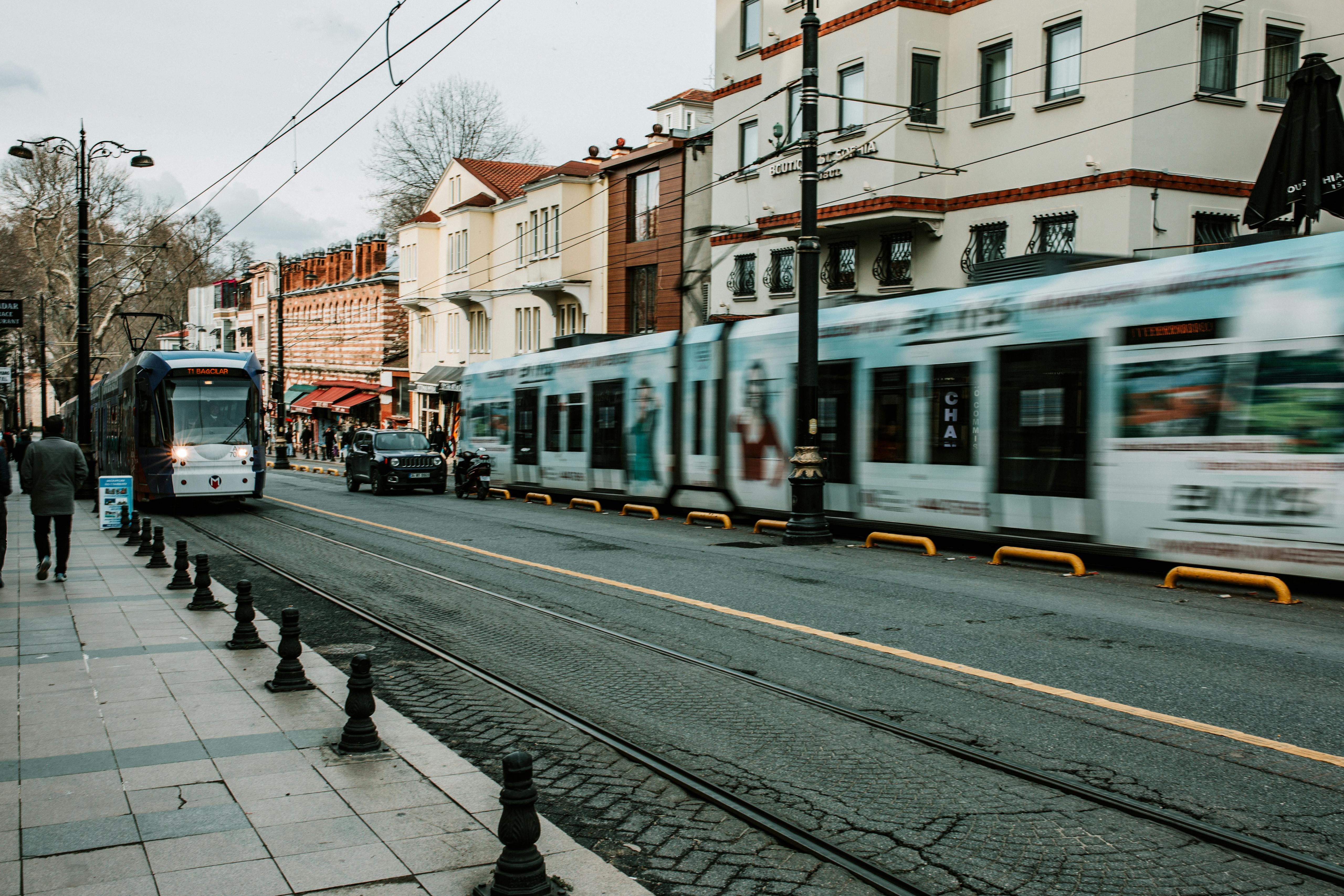 Tram driving along railroad in city · Free Stock Photo