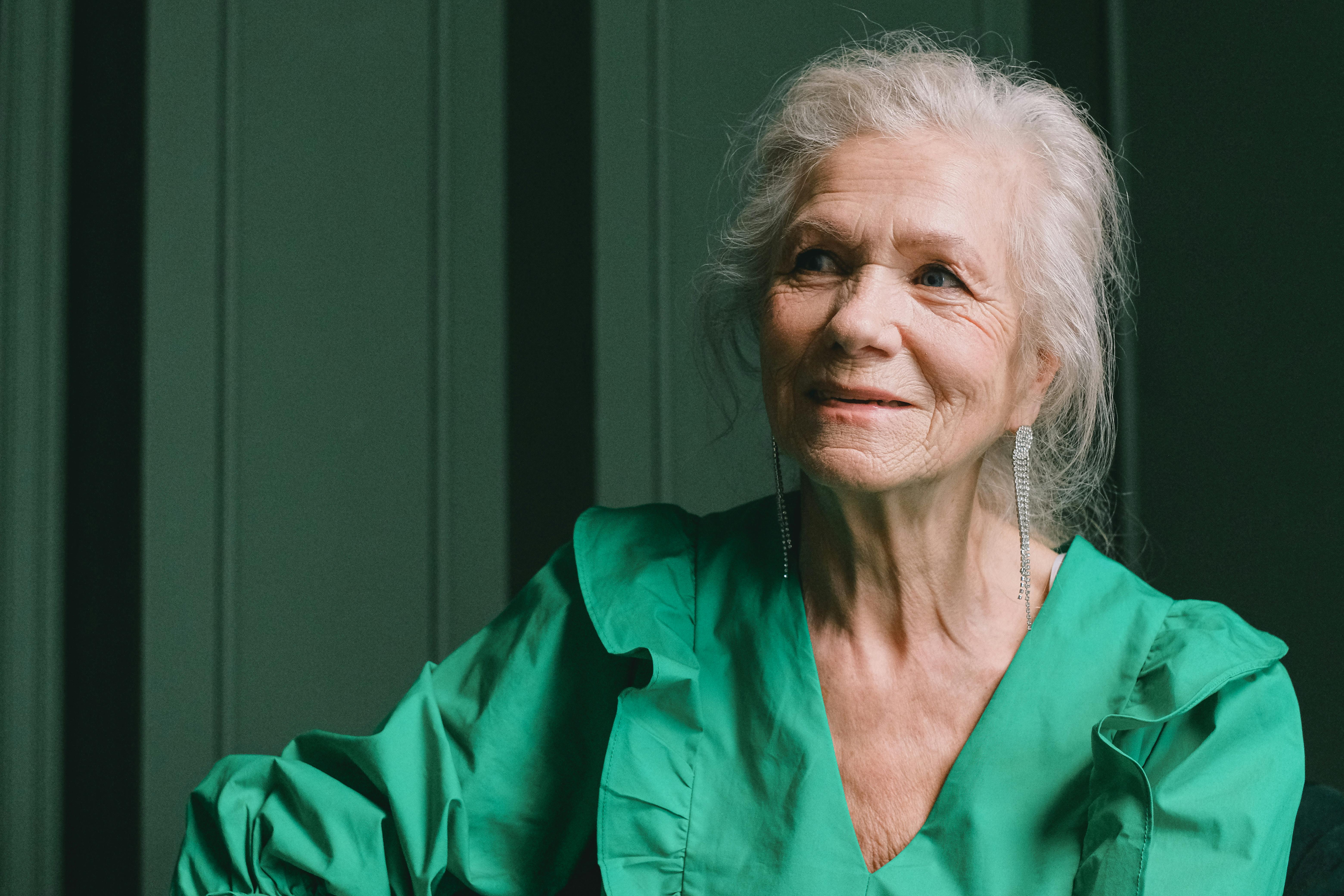Elderly Woman Singing while Holding a Songbook · Free Stock Photo