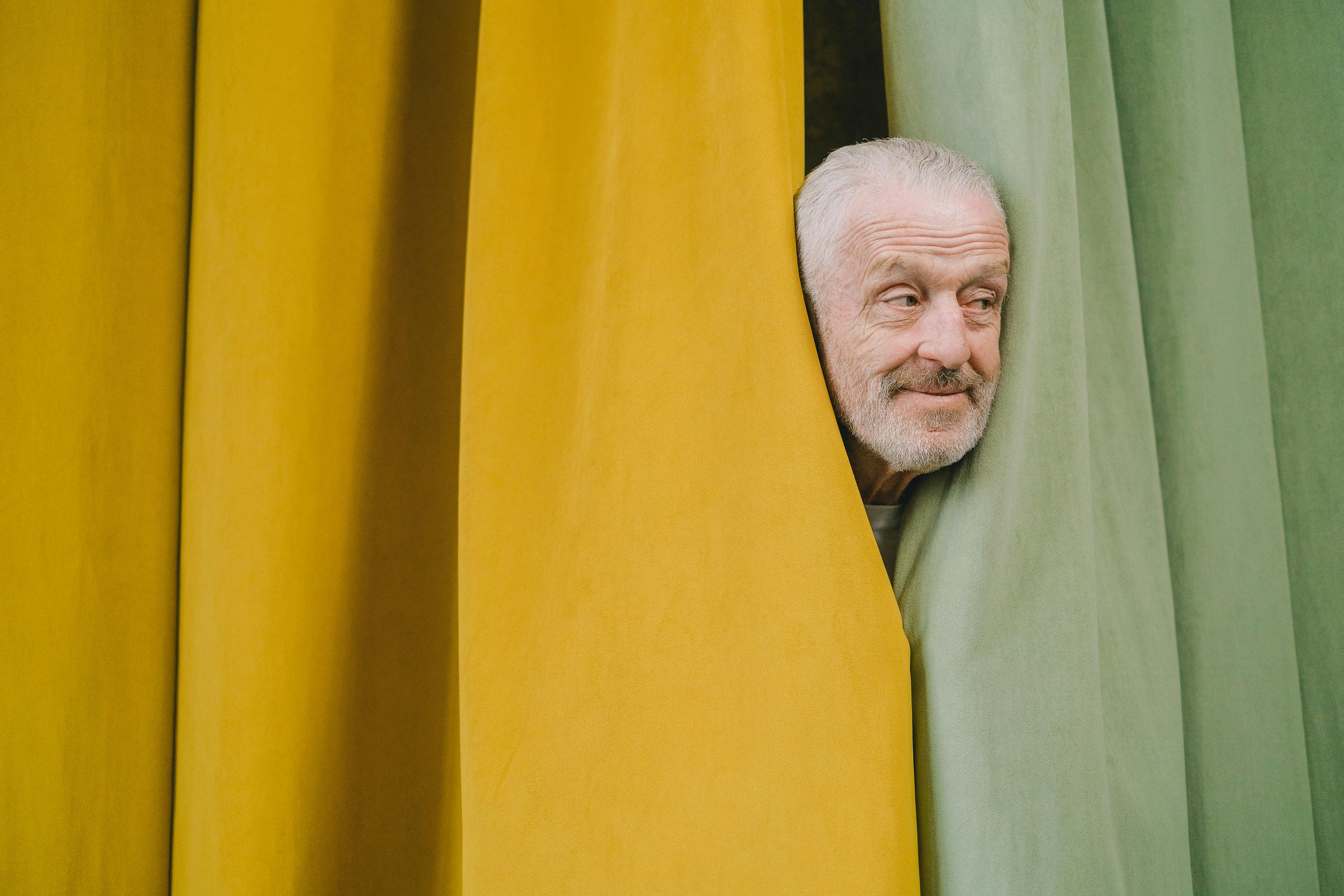 An Elderly Man Behind the Curtain · Free Stock Photo