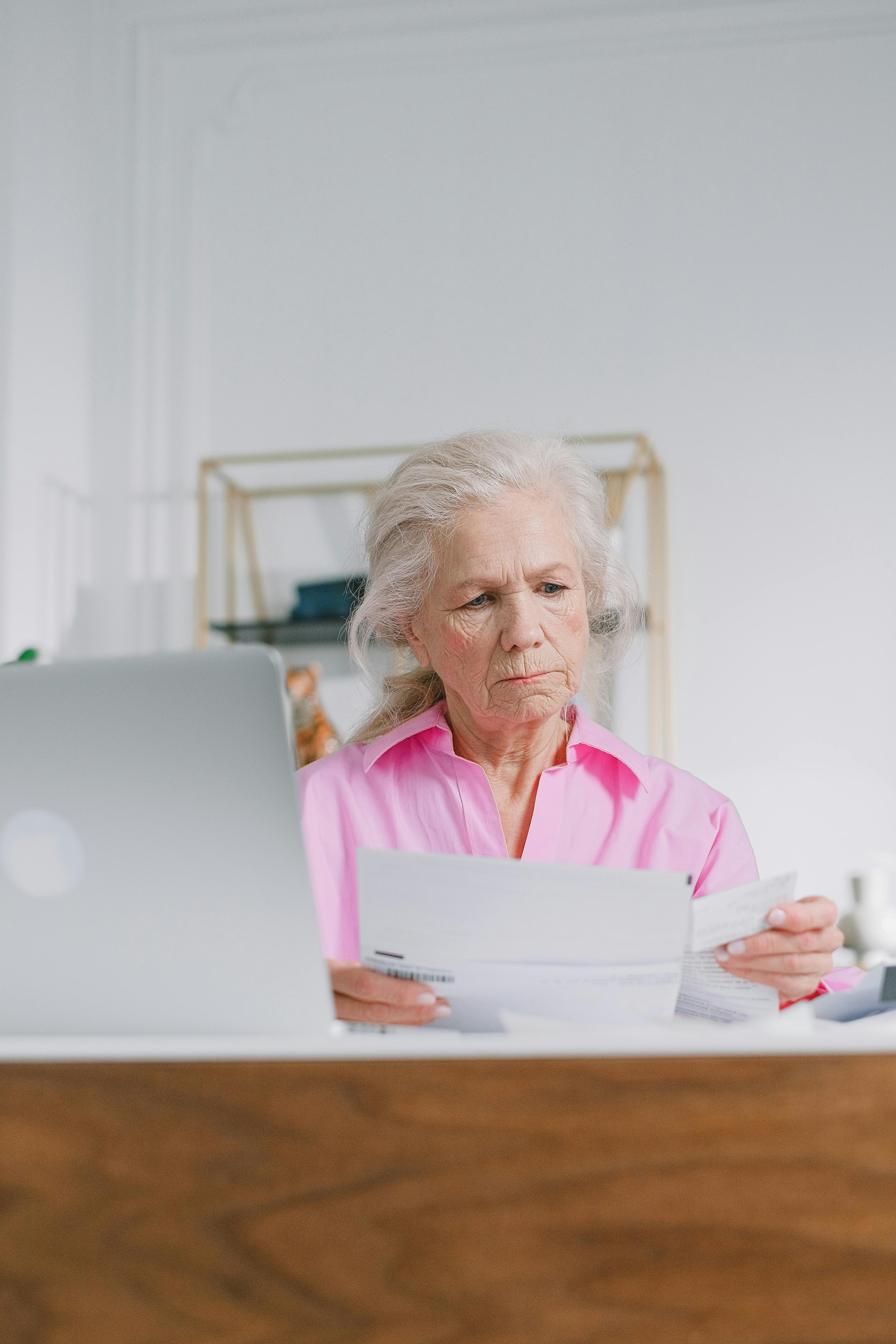 Elderly Woman Looking at Documents · Free Stock Photo