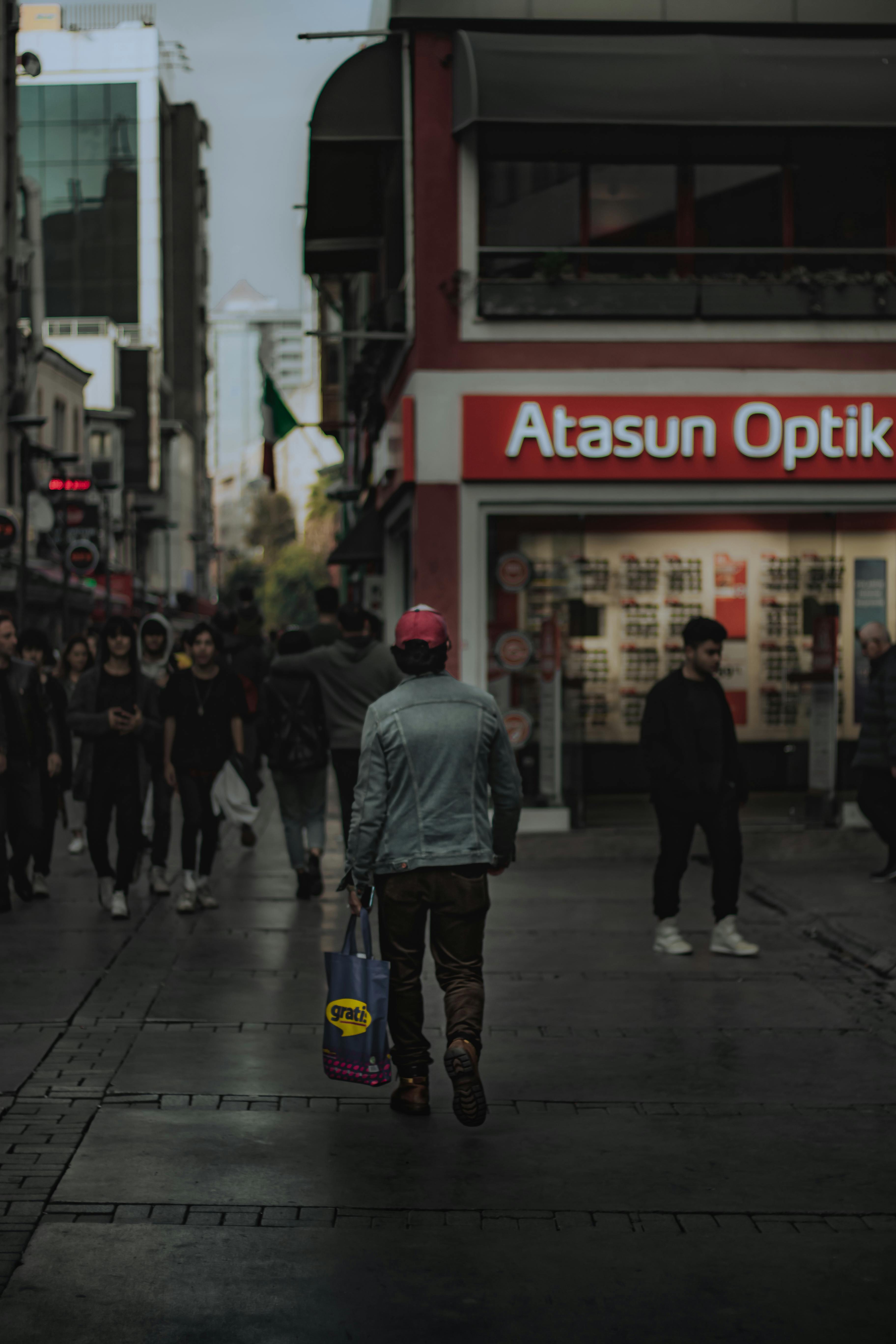 A Back View of a Man Walking on the Street · Free Stock Photo