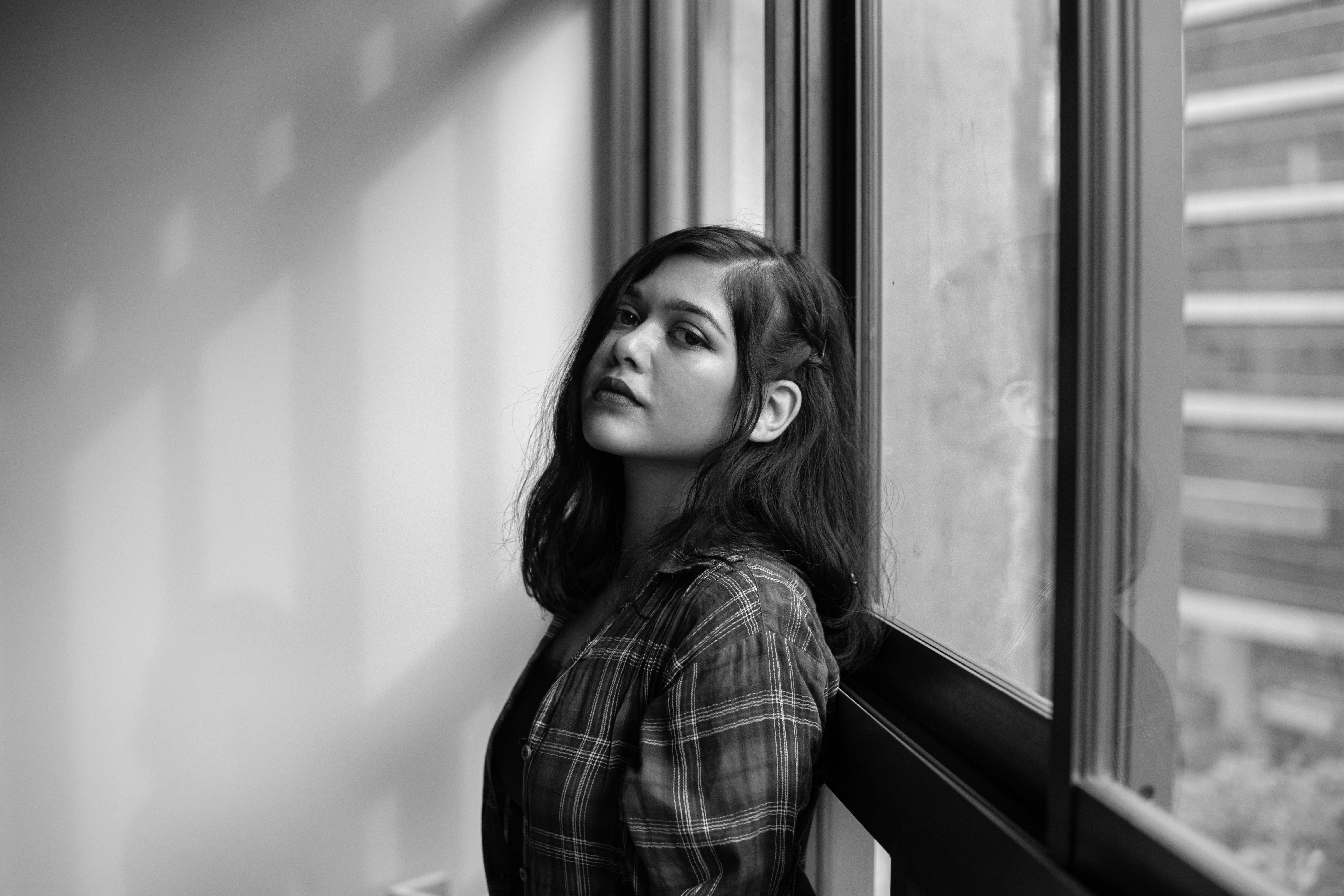 Pretty Woman Behind Glass Panel Window · Free Stock Photo