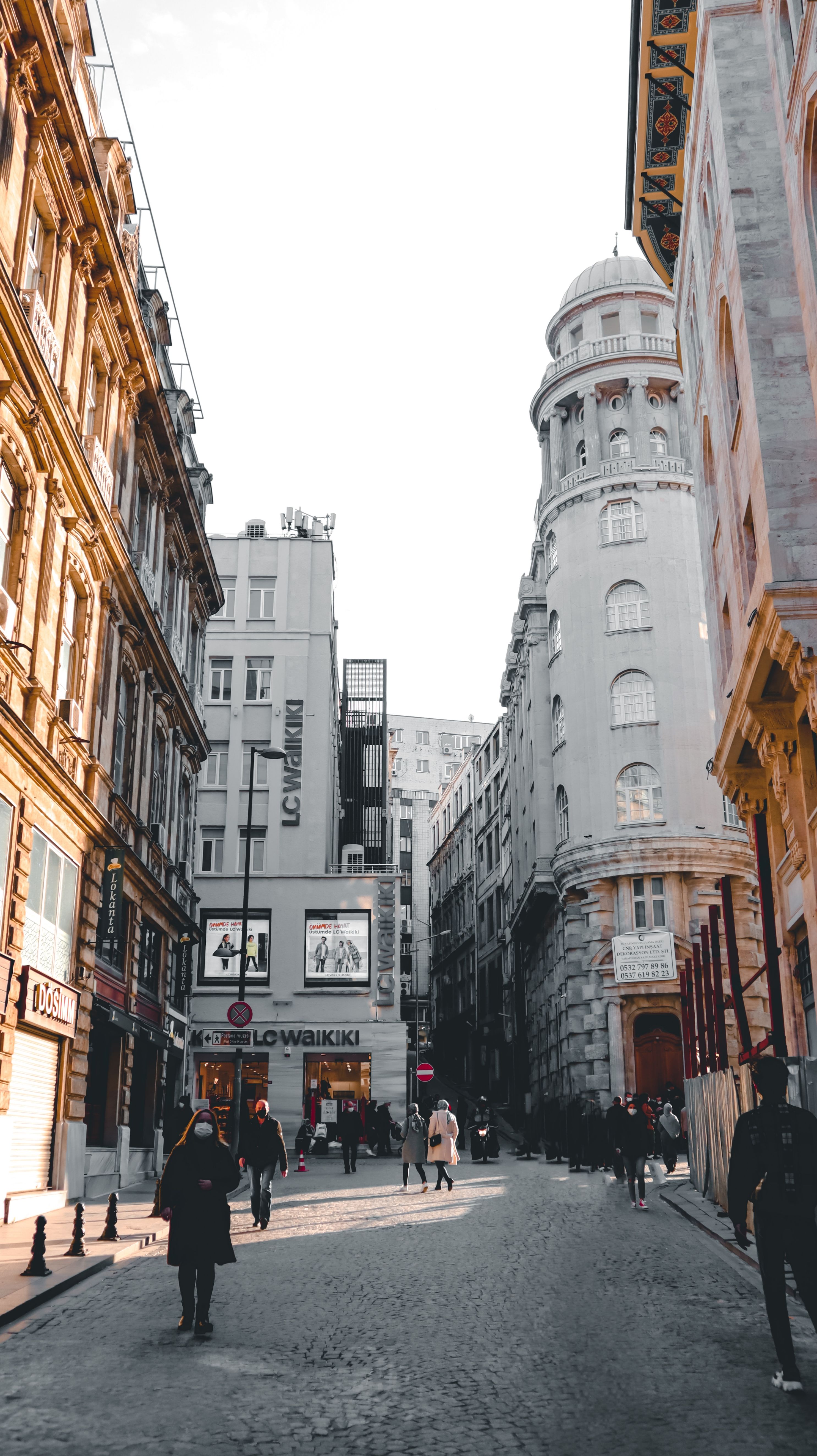 People Walking on the Street Between Buildings · Free Stock Photo