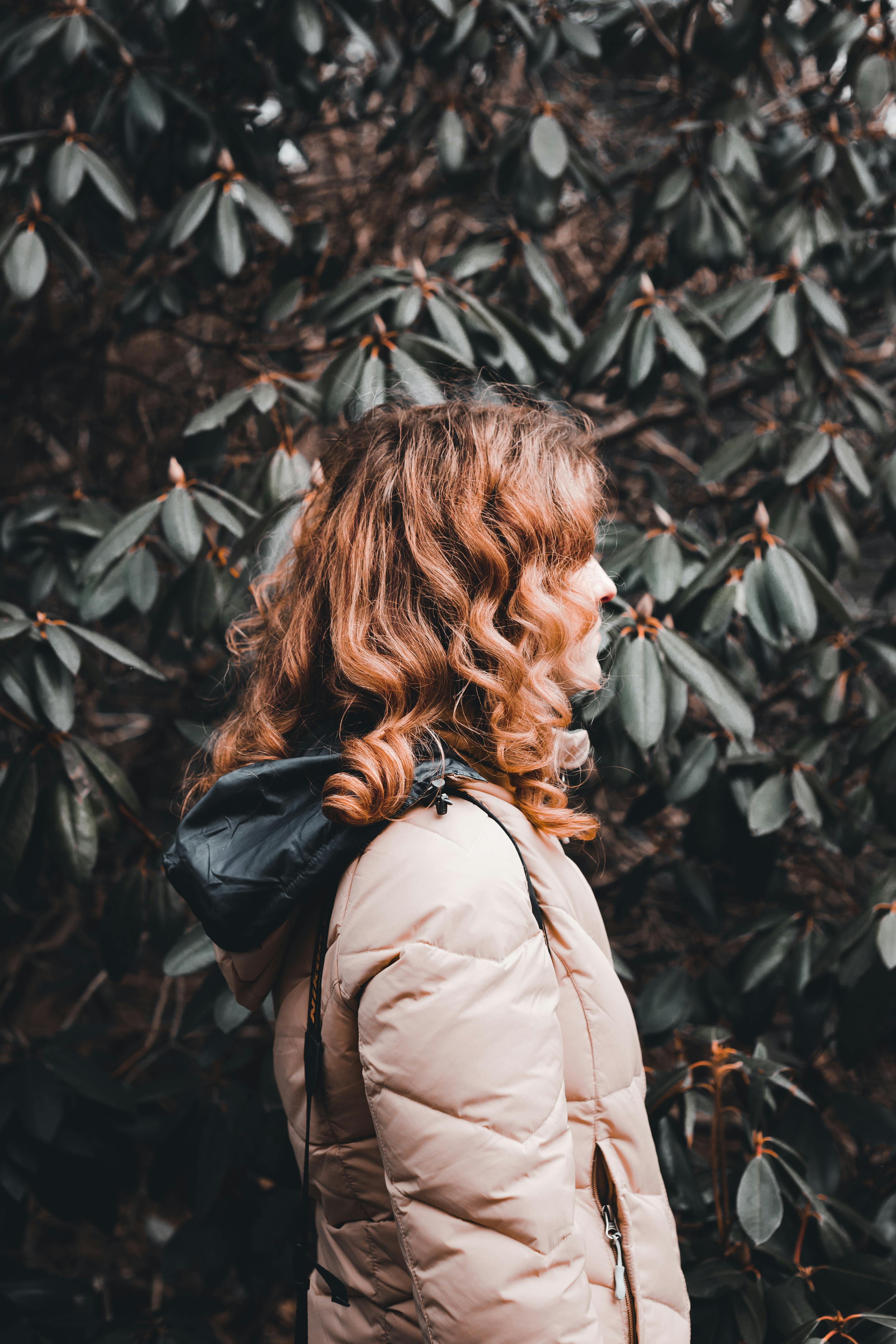 Faceless lady near plants with leaves in nature · Free Stock Photo