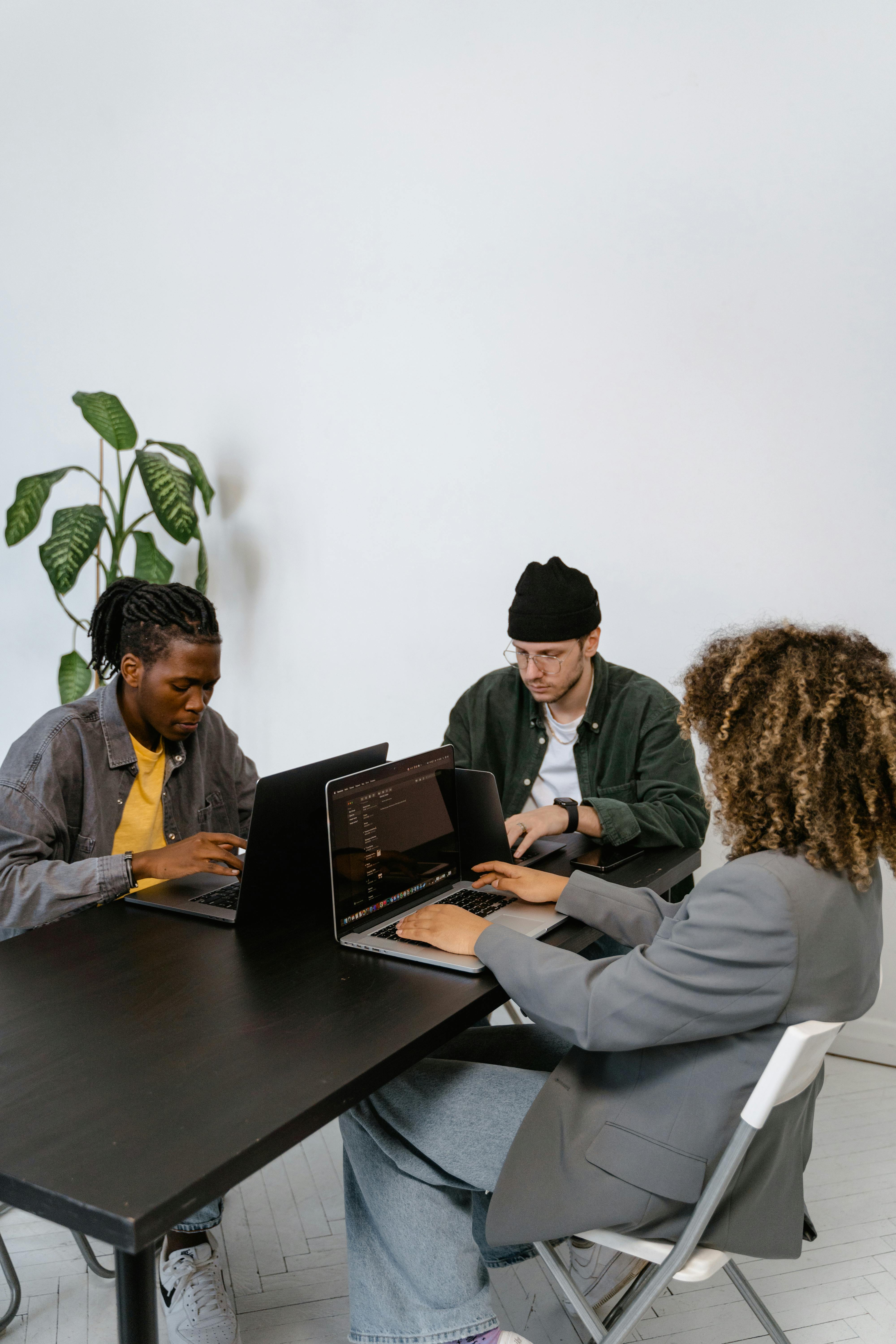 Three People Using Laptops while Working in the Office · Free Stock Photo