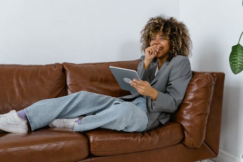 Photo of Three Laughing Woman Sitting on White Couch · Free Stock Photo Photo of Three Laughing Woman Sitting on White Couch · Free Stock Photo