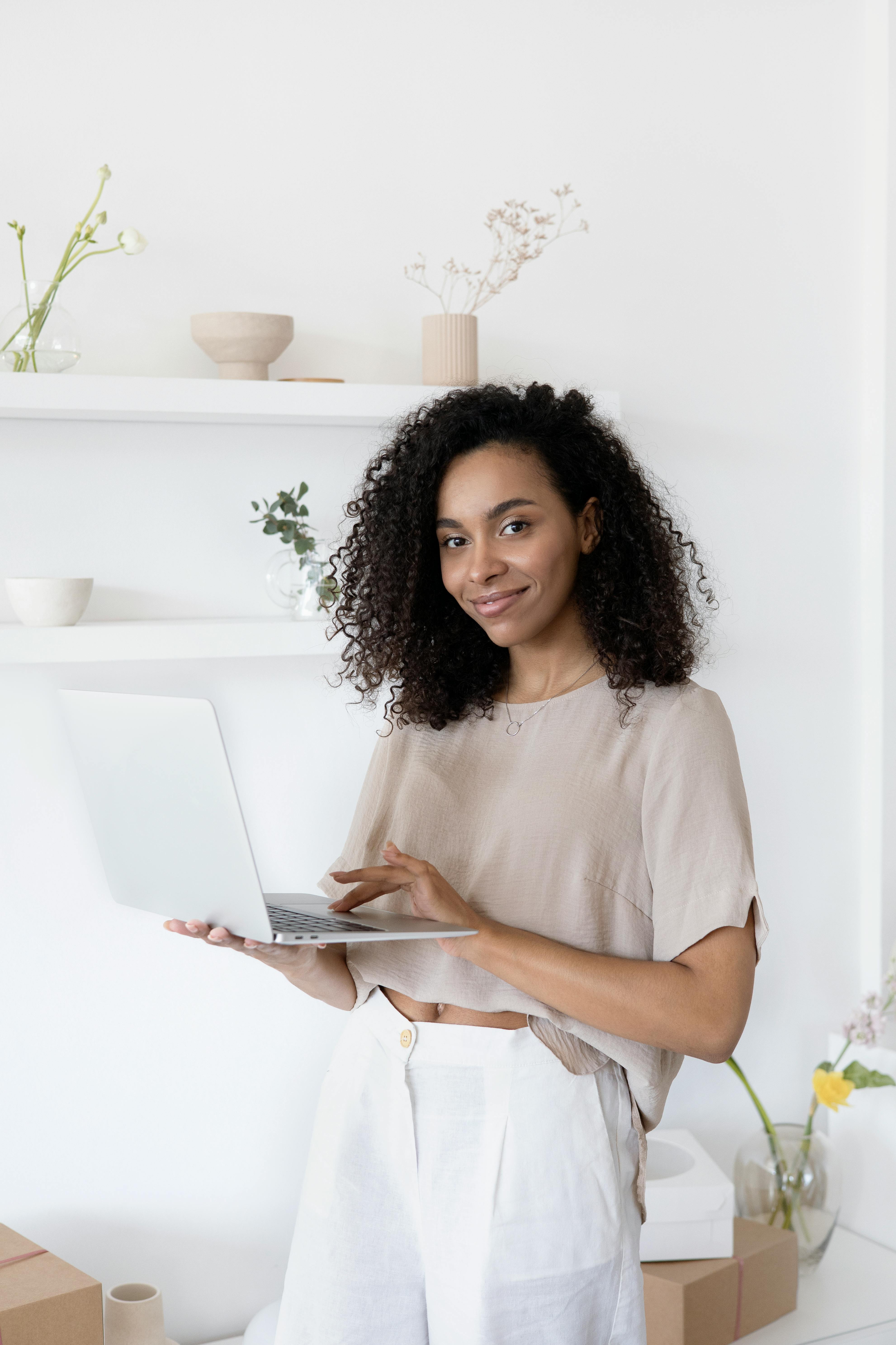 A Woman Holding a Laptop · Free Stock Photo