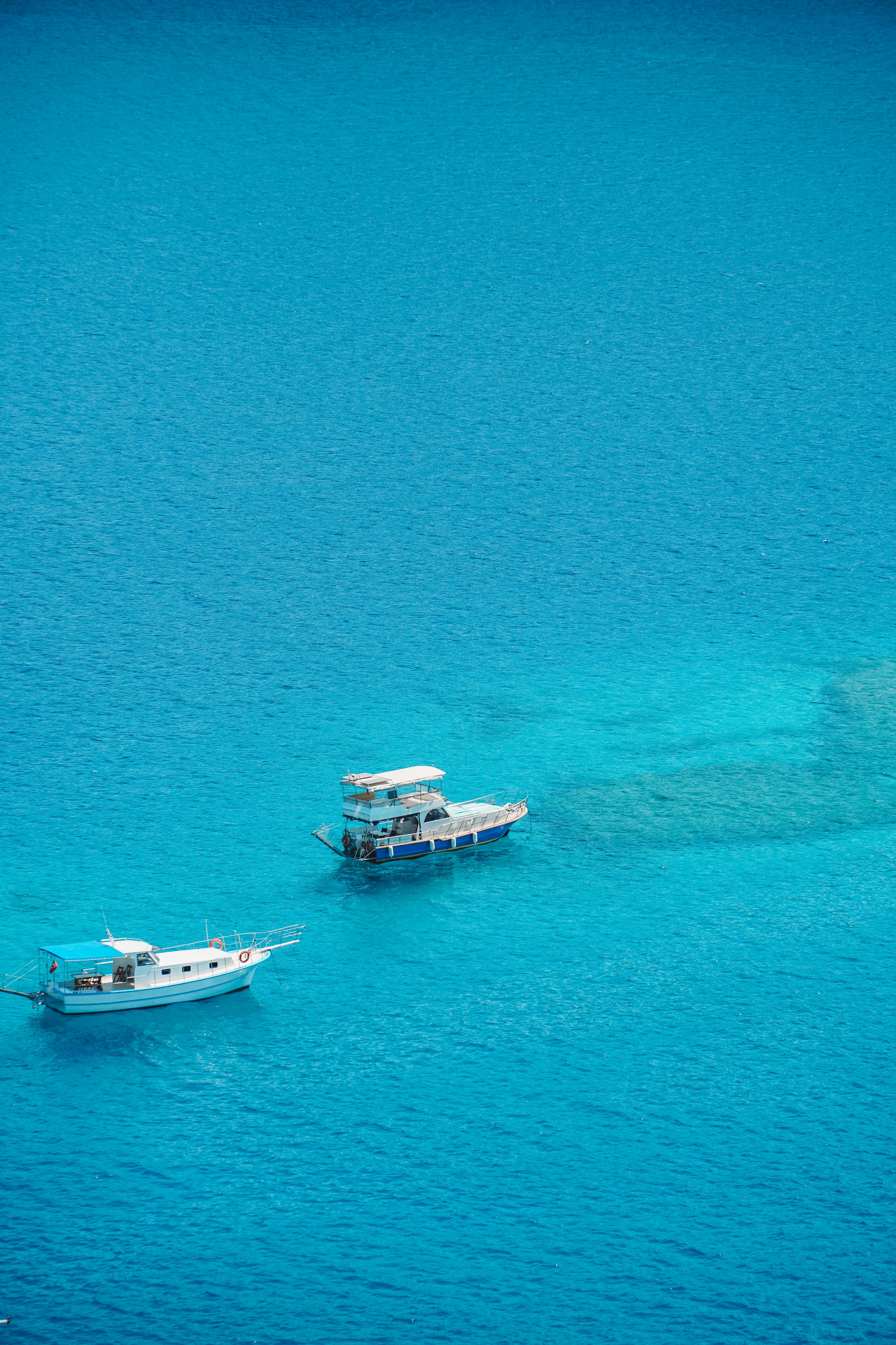 White and Blue Boats on Blue Sea · Free Stock Photo