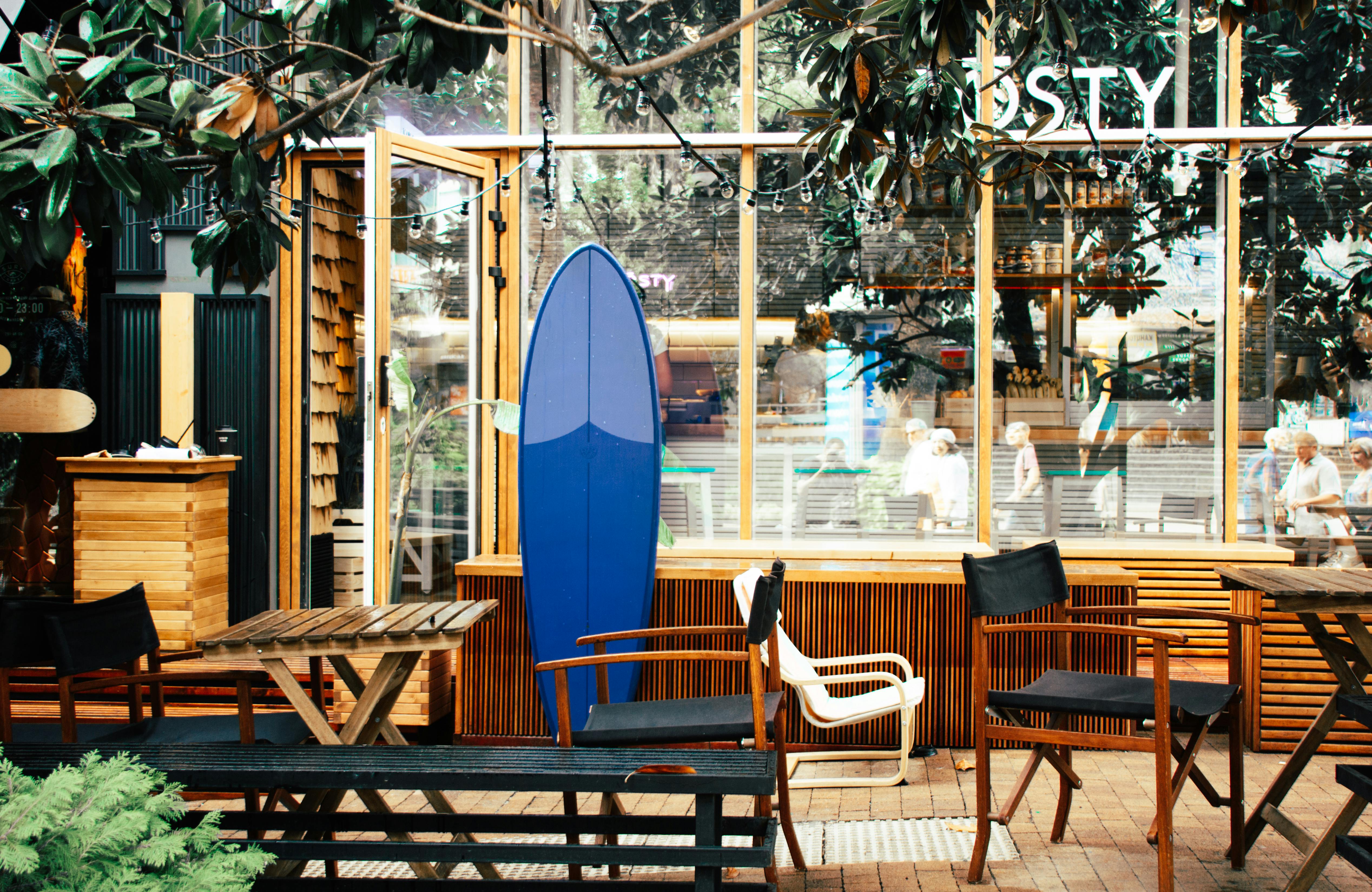 Blue Surfboard Leaning on Desk · Free Stock Photo