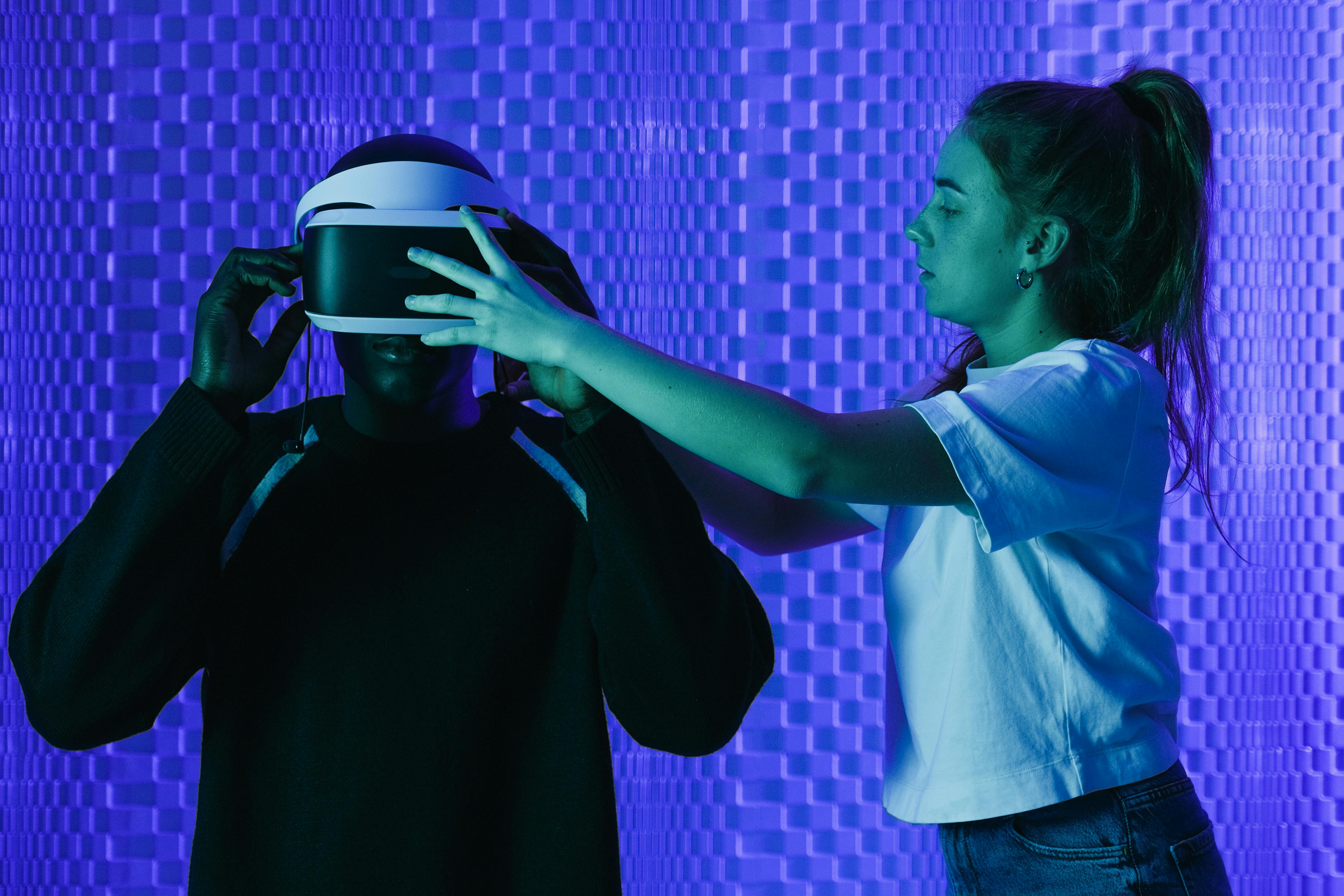 Girl Helping a Man with Putting on a VR Headset · Free Stock Photo