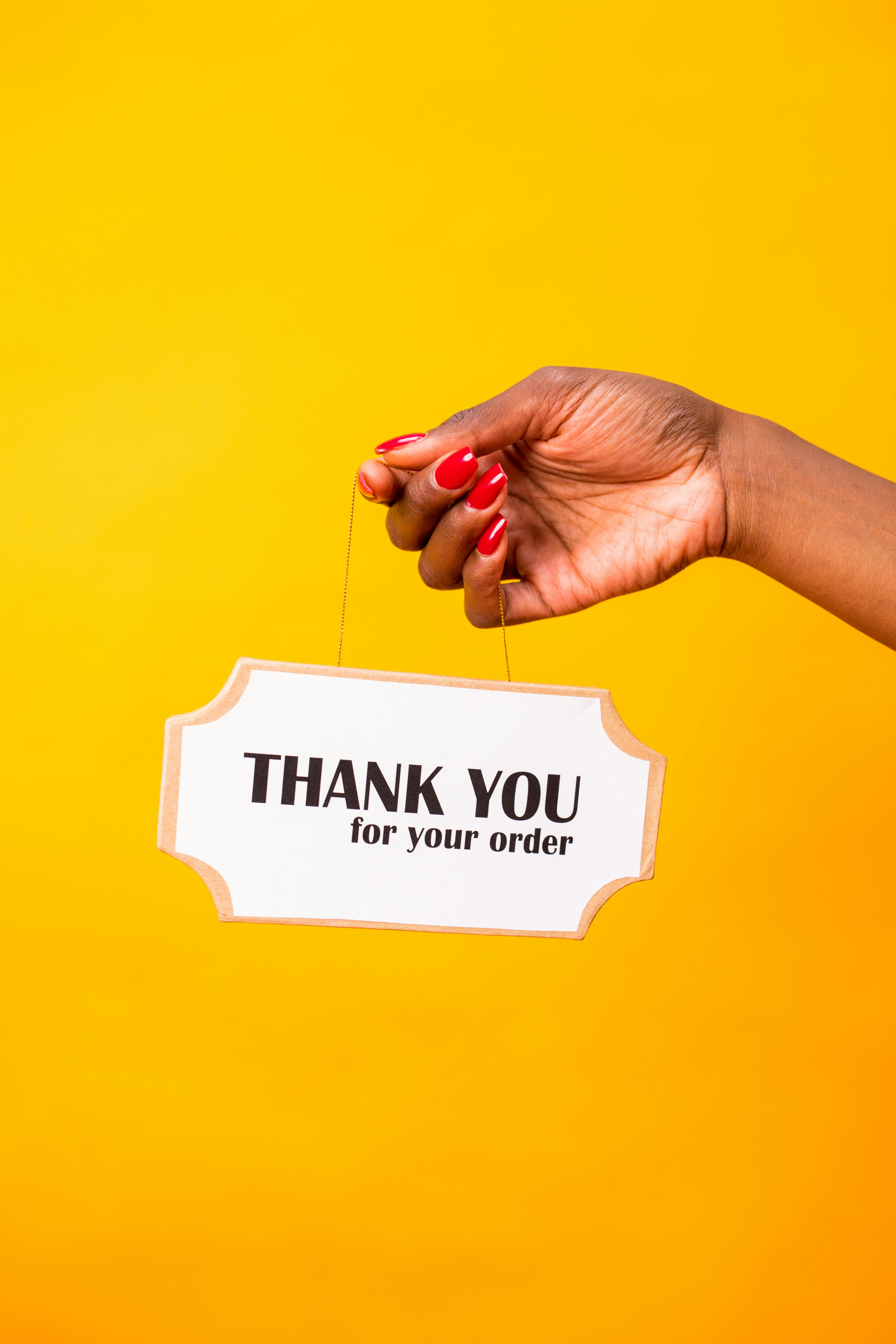 A Person Holding a Thank You Signage · Free Stock Photo