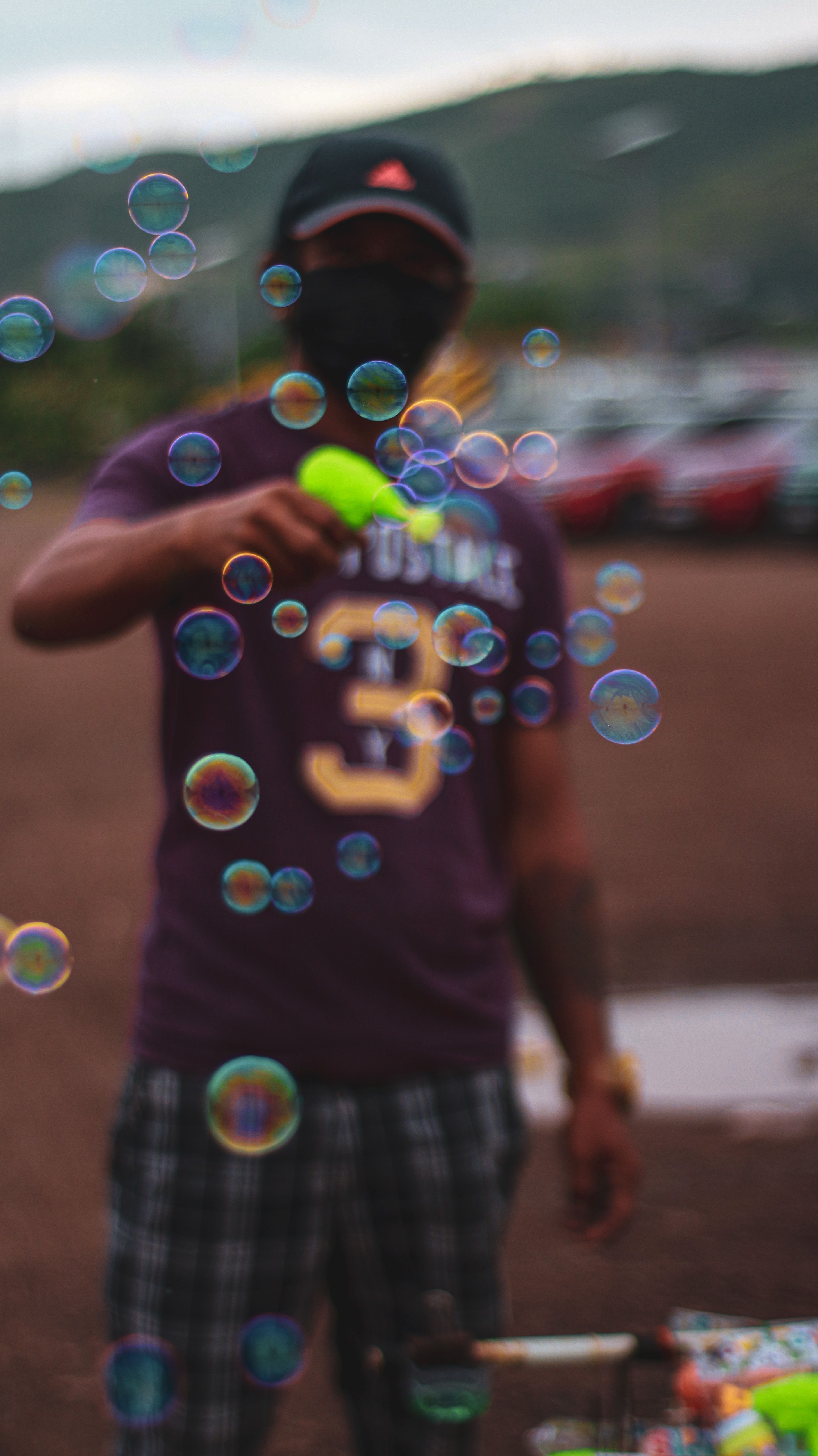 Man Shooting Soap Bubbles from a Soap Bubbles Gun · Free Stock Photo