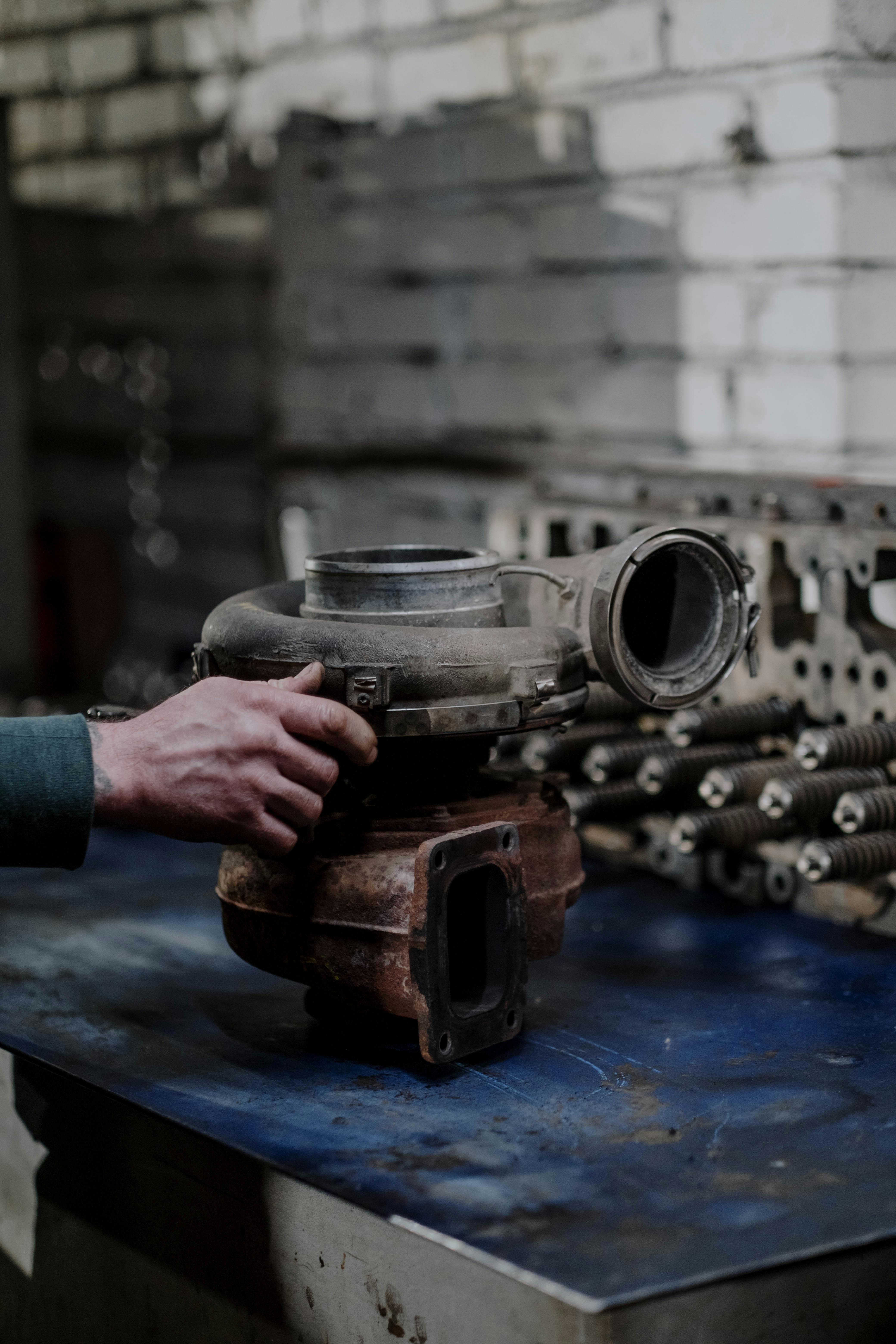 Person Holding a Rusty Engine Turbo · Free Stock Photo