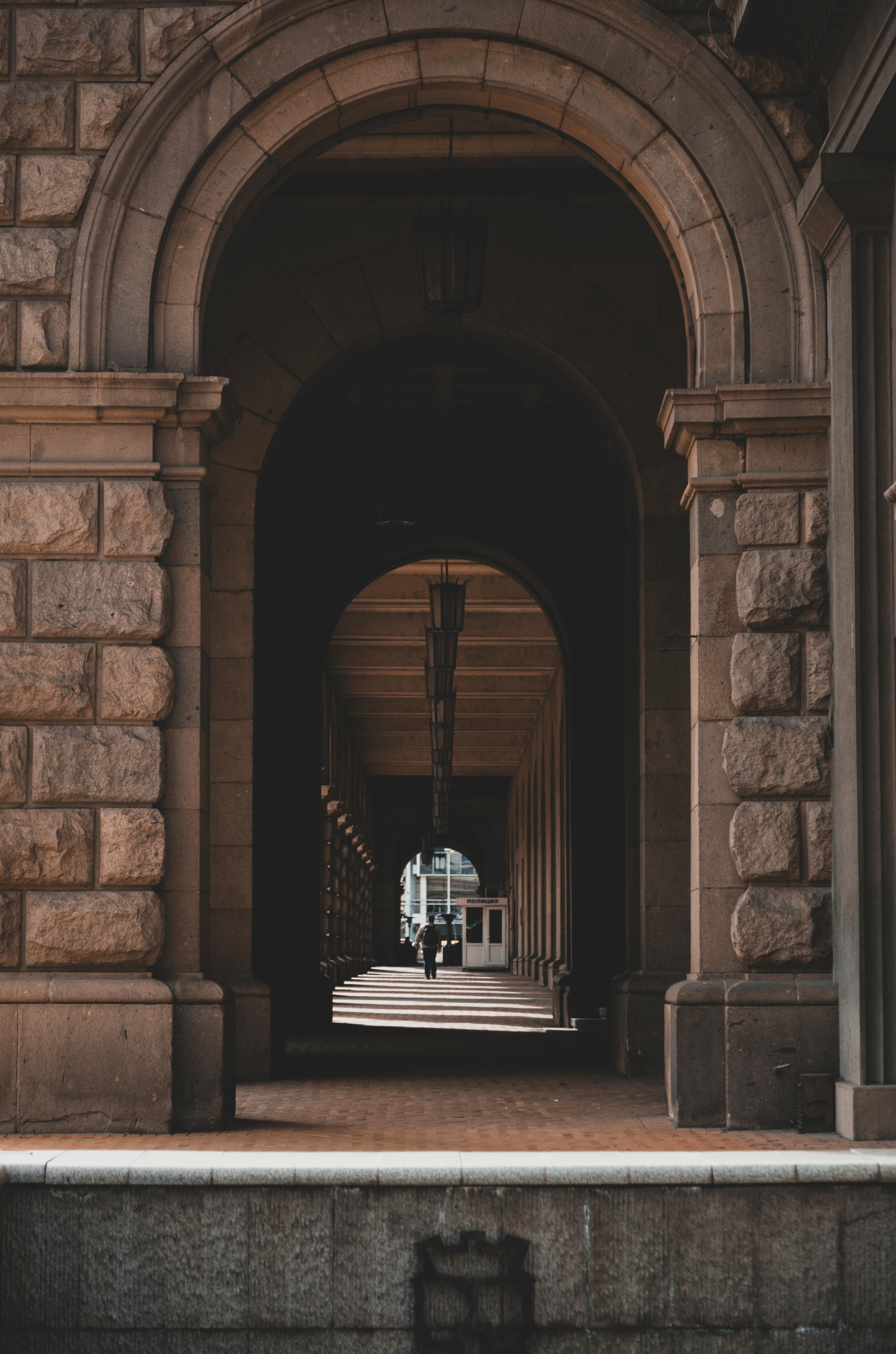 Symmetrical View of a Walkway under an Arcade · Free Stock Photo