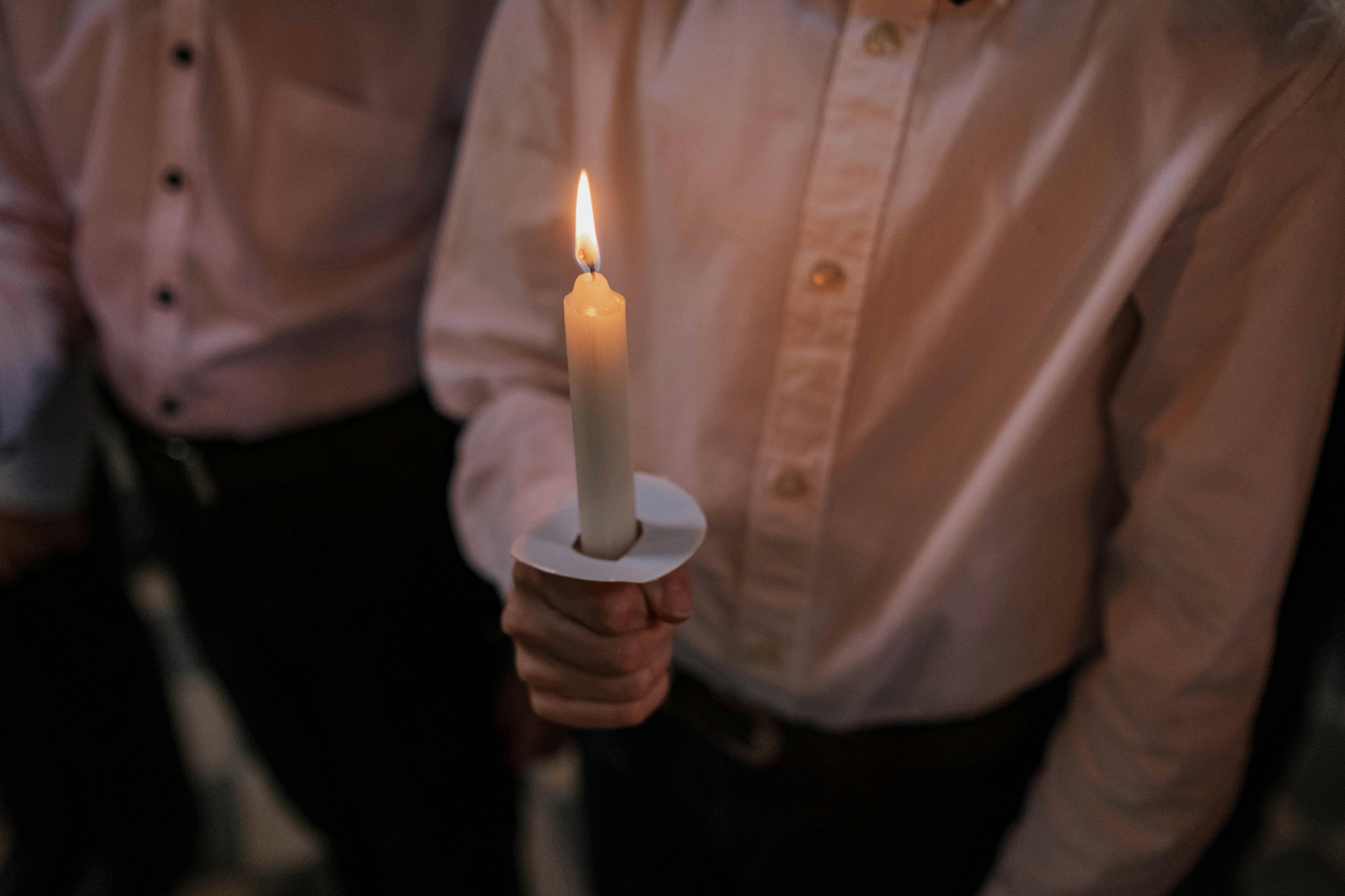 Hand Holding White Lighted Candle · Free Stock Photo