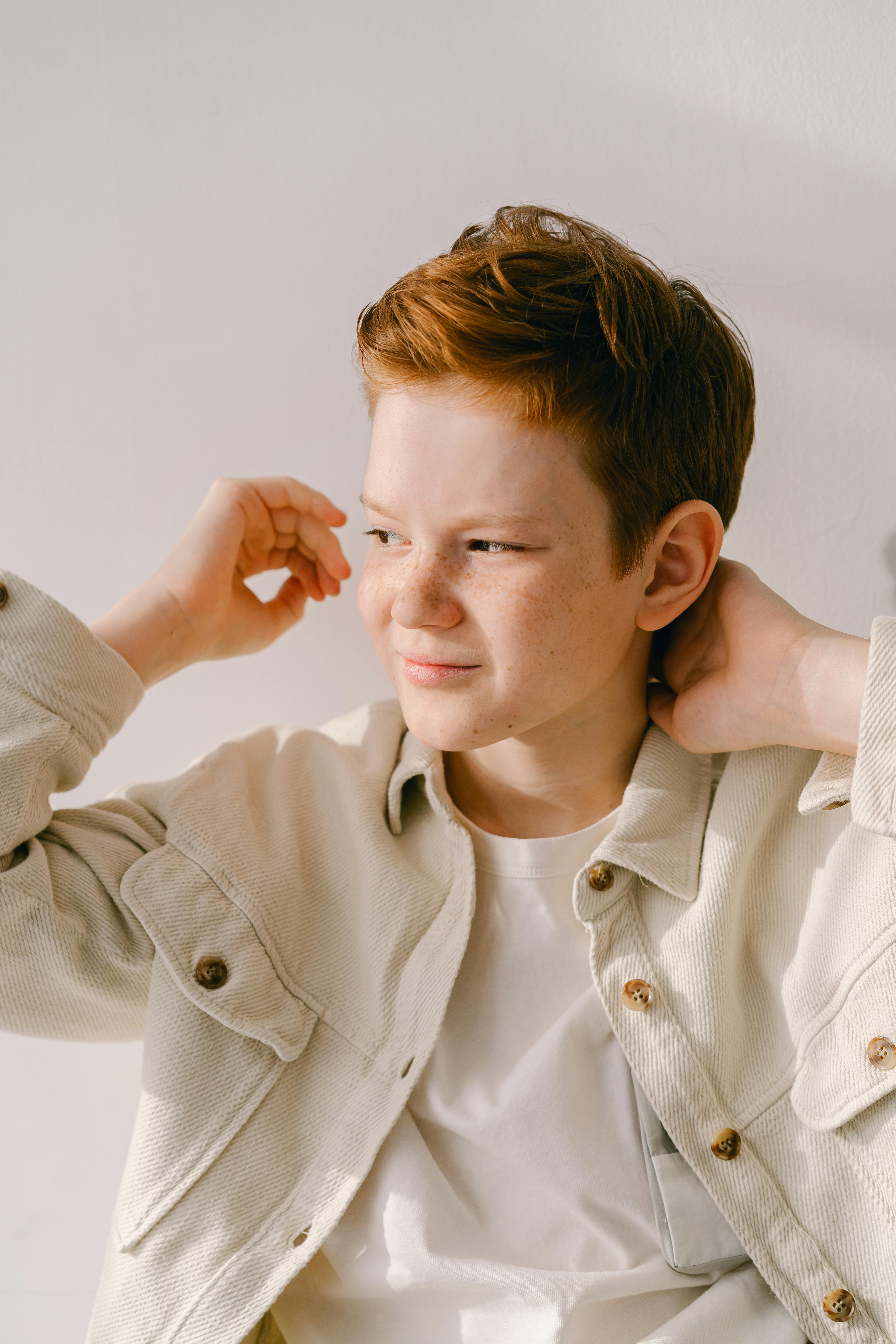 Portrait of a Boy Fixing His Hair · Free Stock Photo