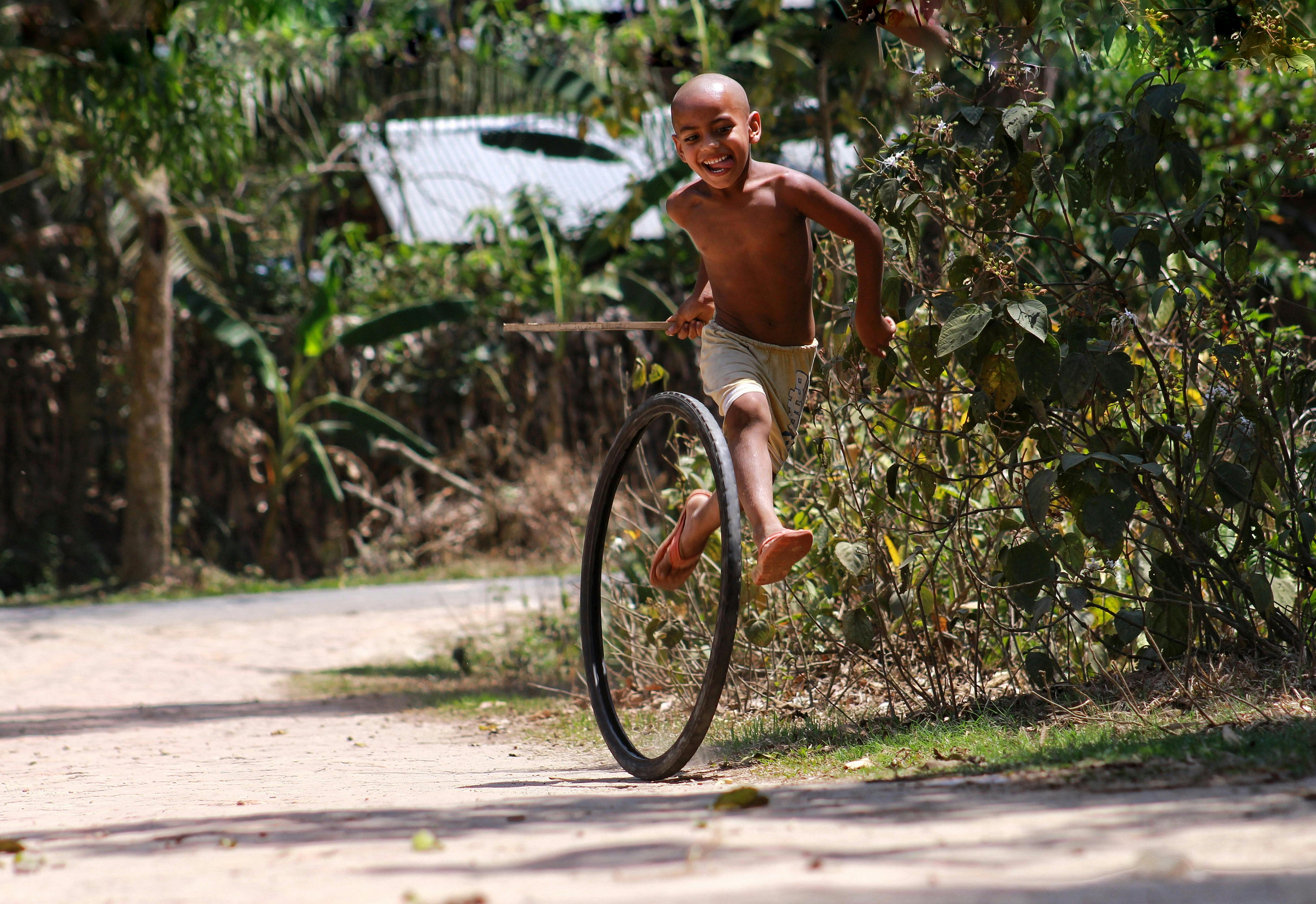 Shirtless Children Holding a Red and White Flag · Free Stock Photo
