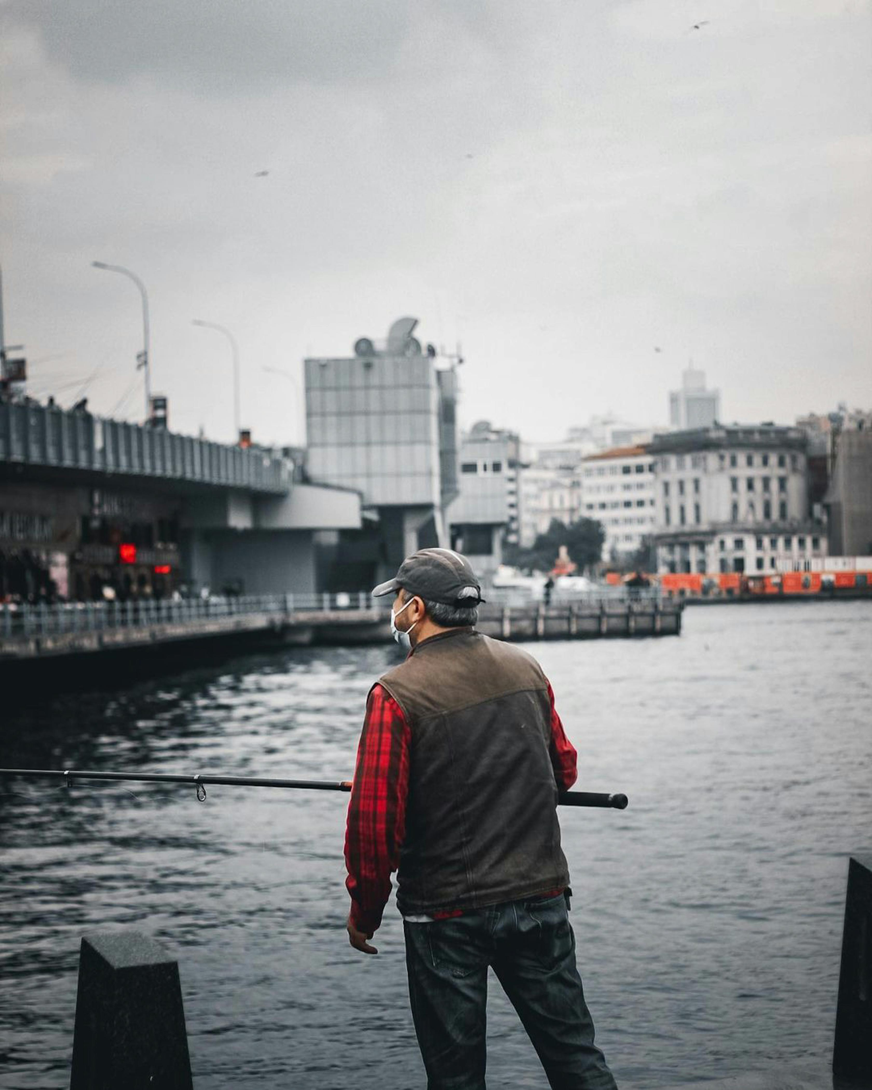 Man with a Fishing Rod on a Cliff · Free Stock Photo